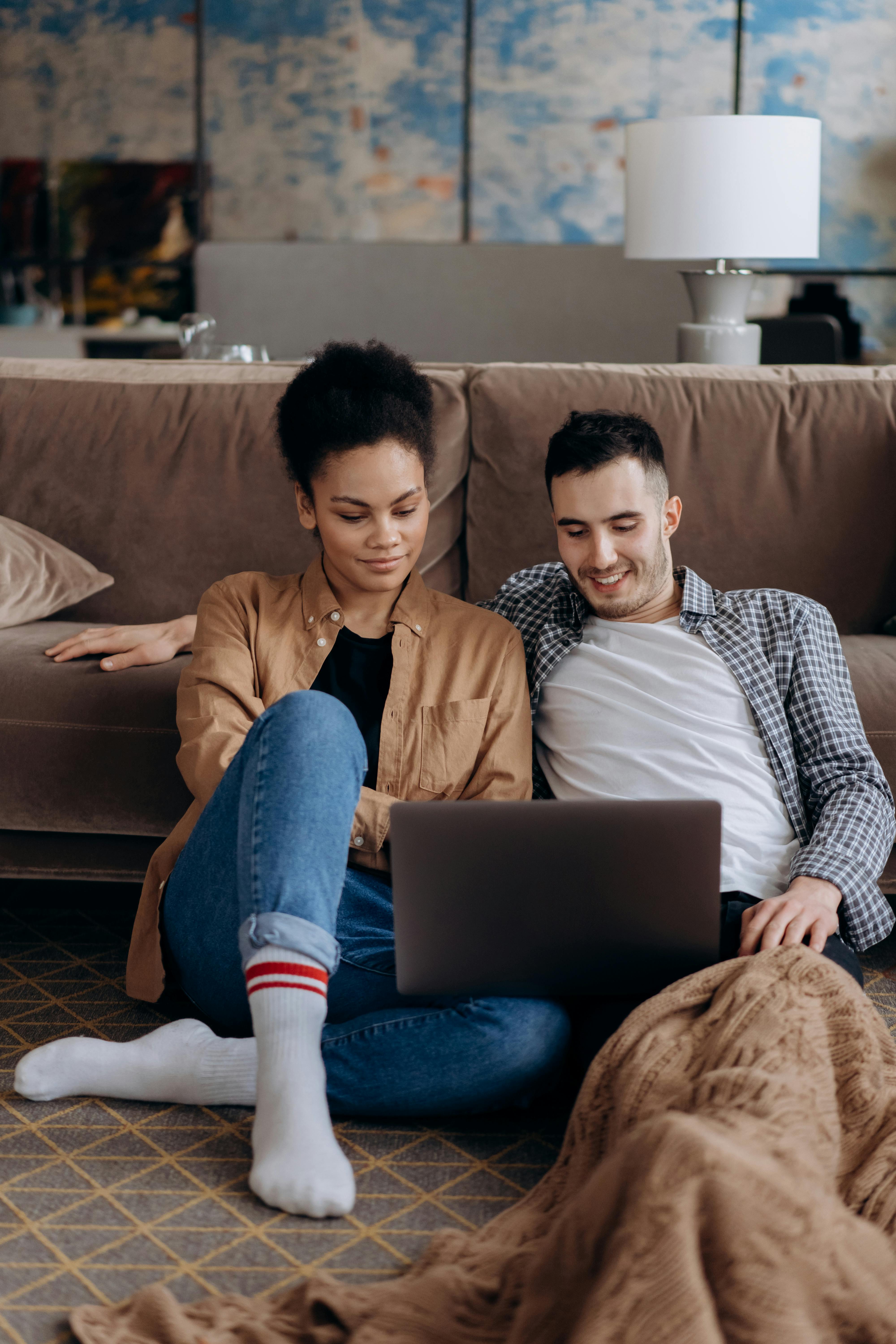 A Couple Using Laptop While Sitting on the Floor · Free Stock Photo