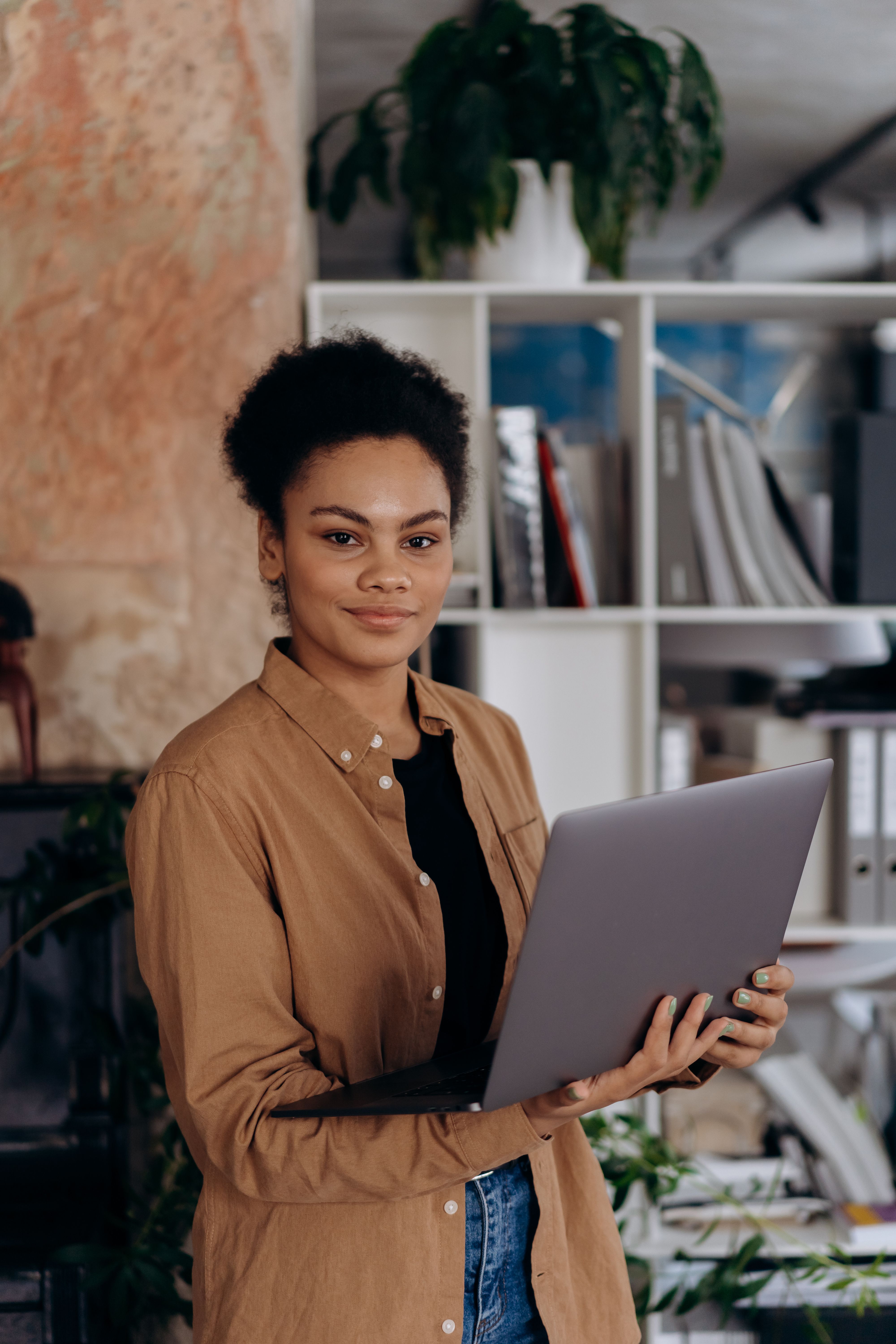 A Woman Holding a Laptop · Free Stock Photo