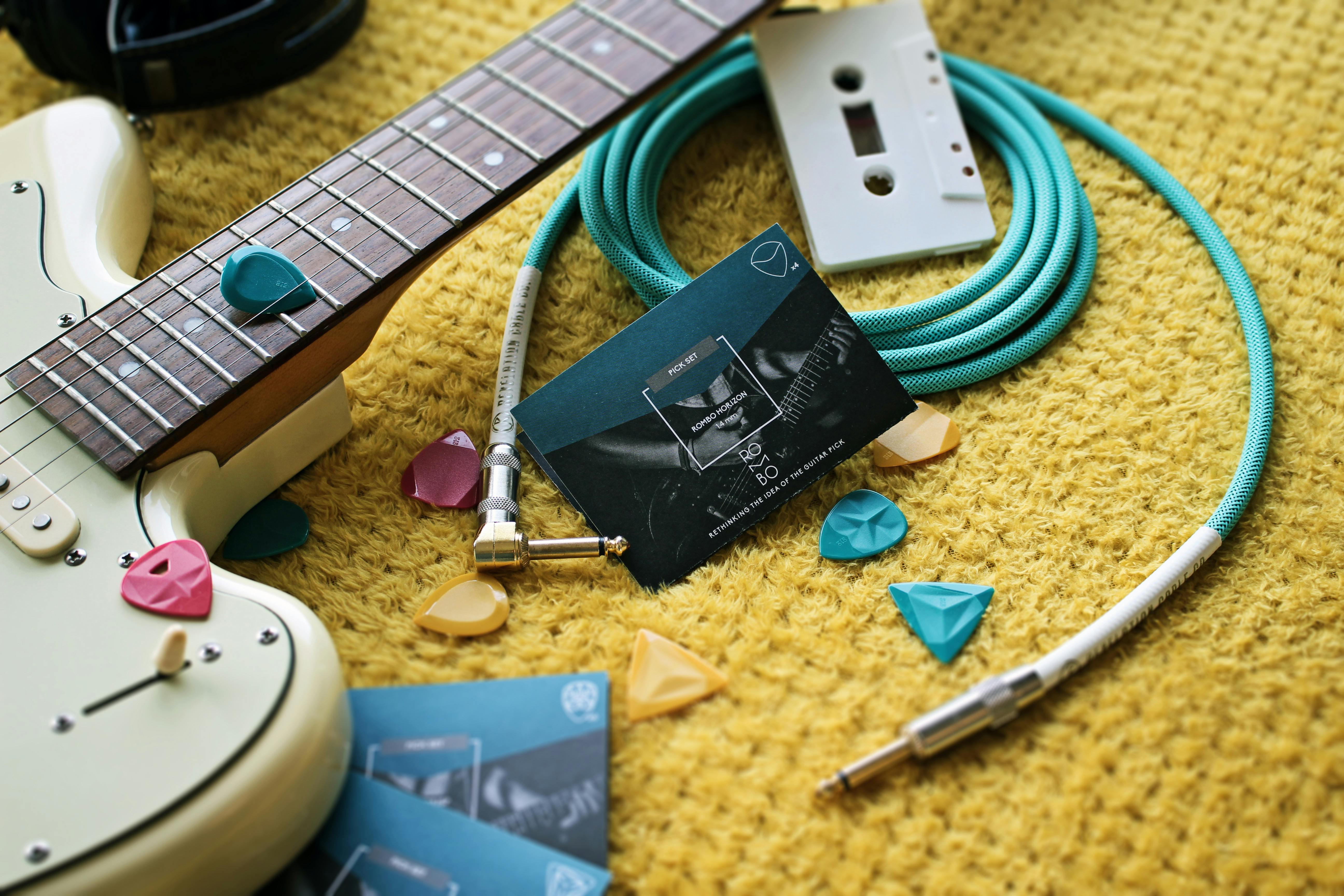 Colorful Guitar Picks on the Carpet Beside the Electric Guitar · Free ...