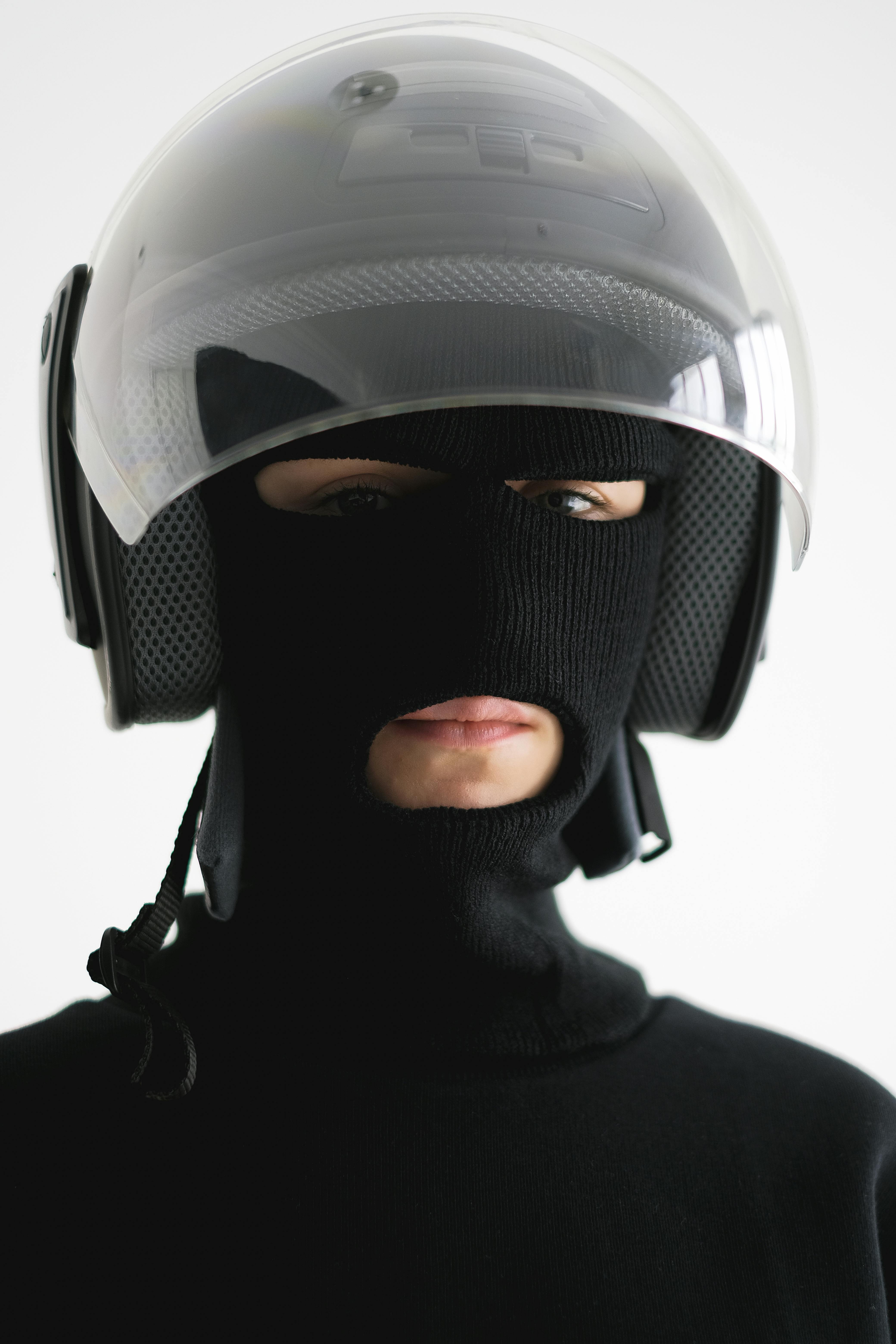 A Person Wearing a Helmet and a Black Full Face Mask · Free Stock Photo