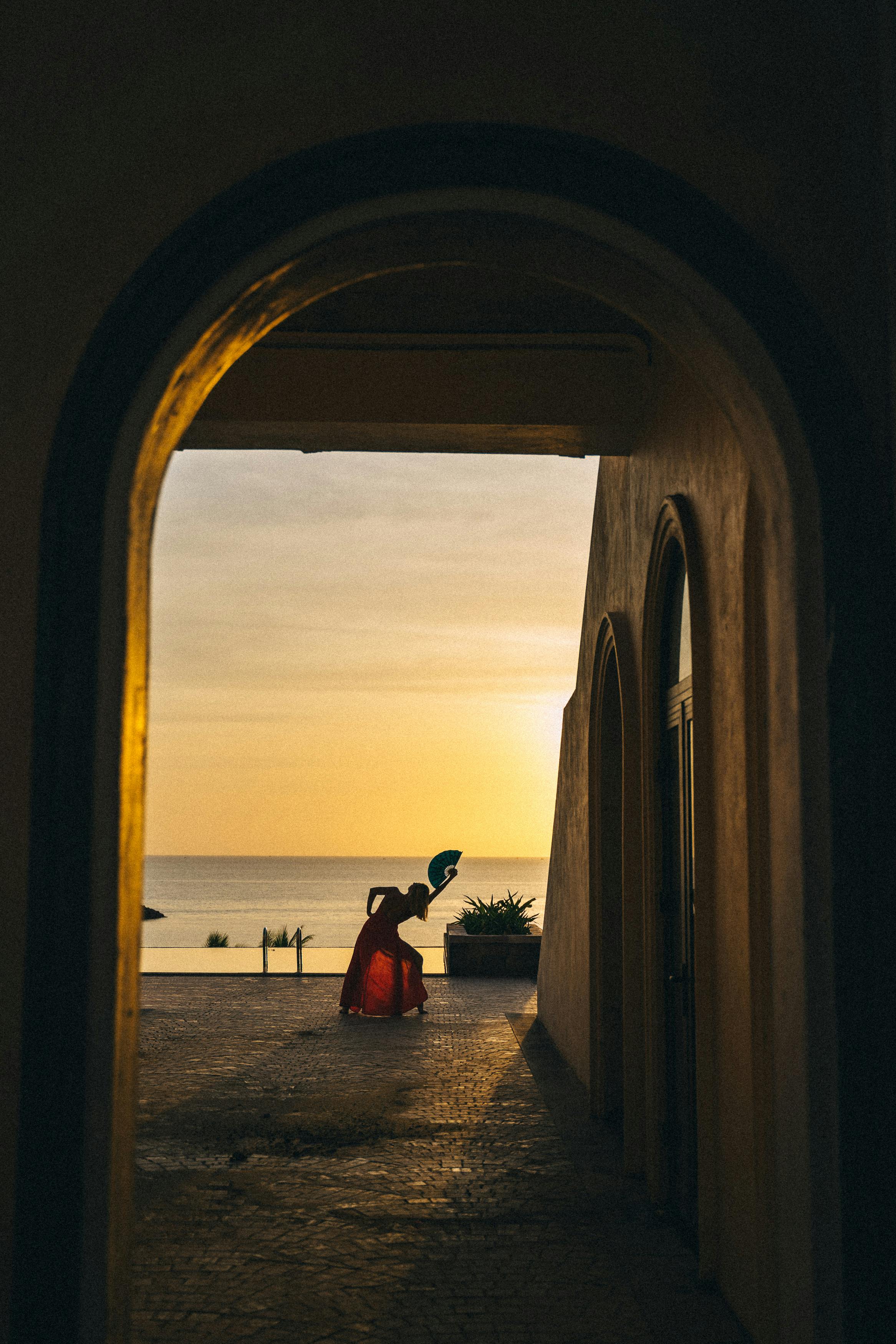Person in Red Dress Dancing During Golden Hour · Free Stock Photo