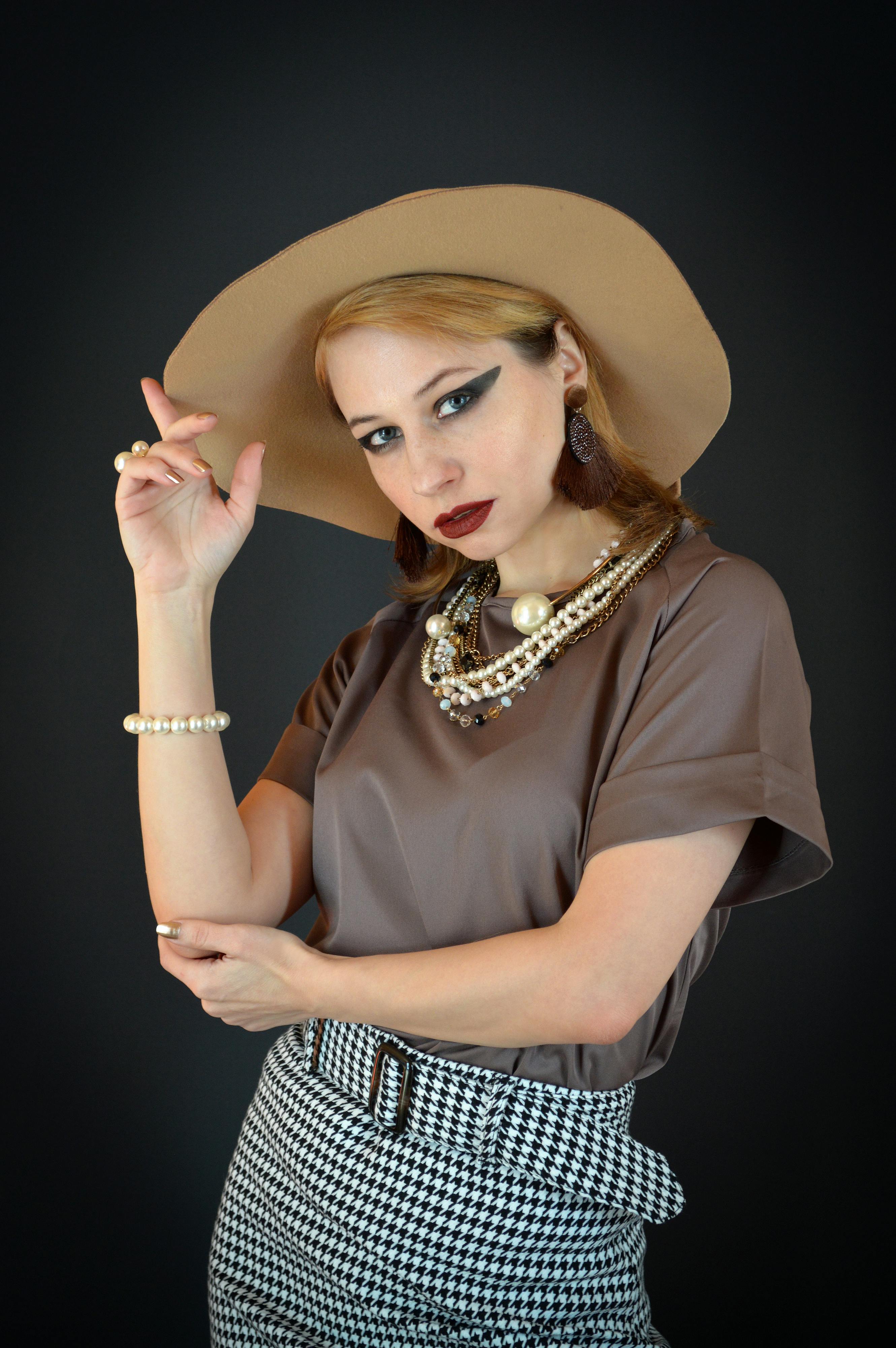 Eccentric woman in stylish outfit in studio · Free Stock Photo