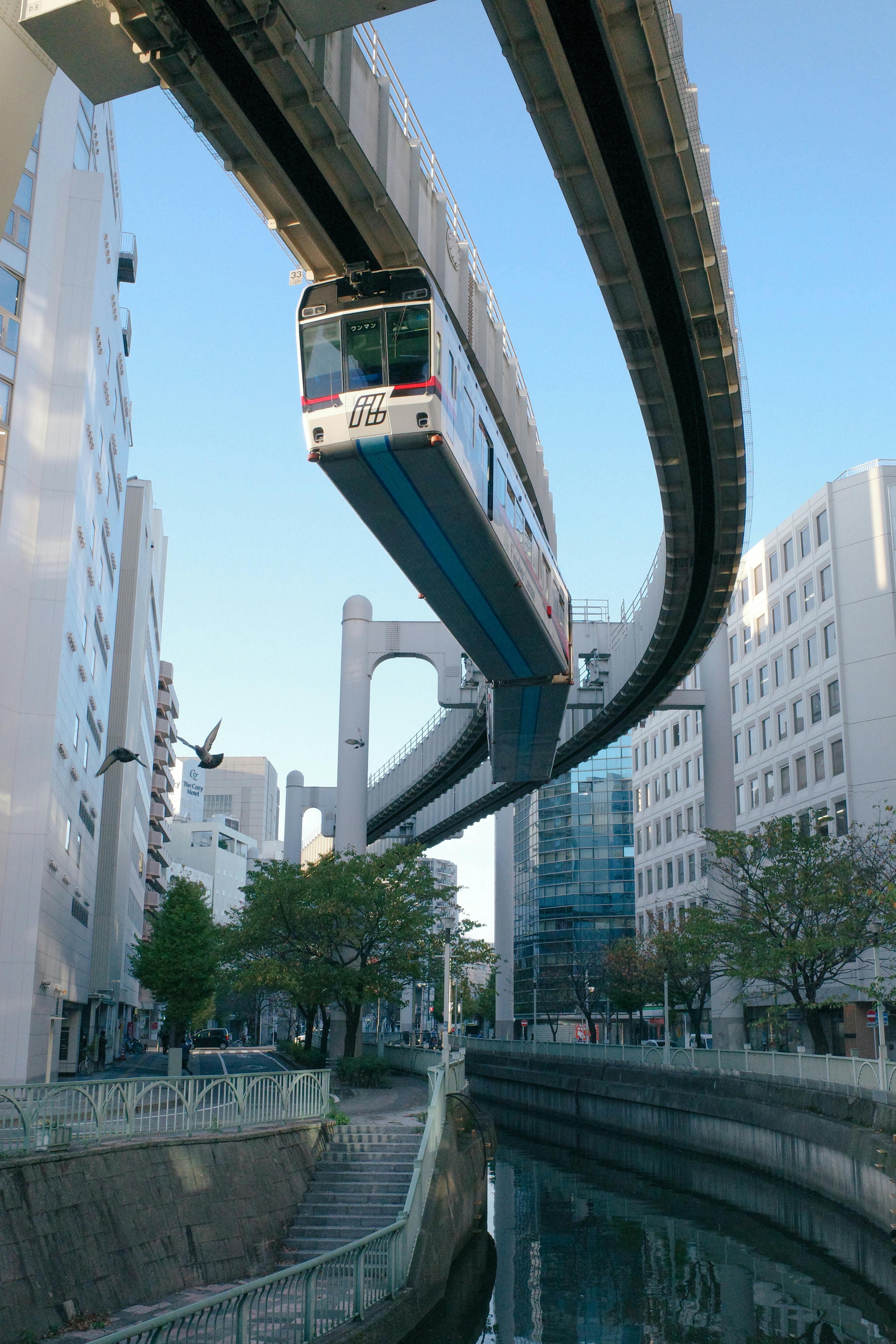 A Monorail Train Between High Rise Buildings · Free Stock Photo