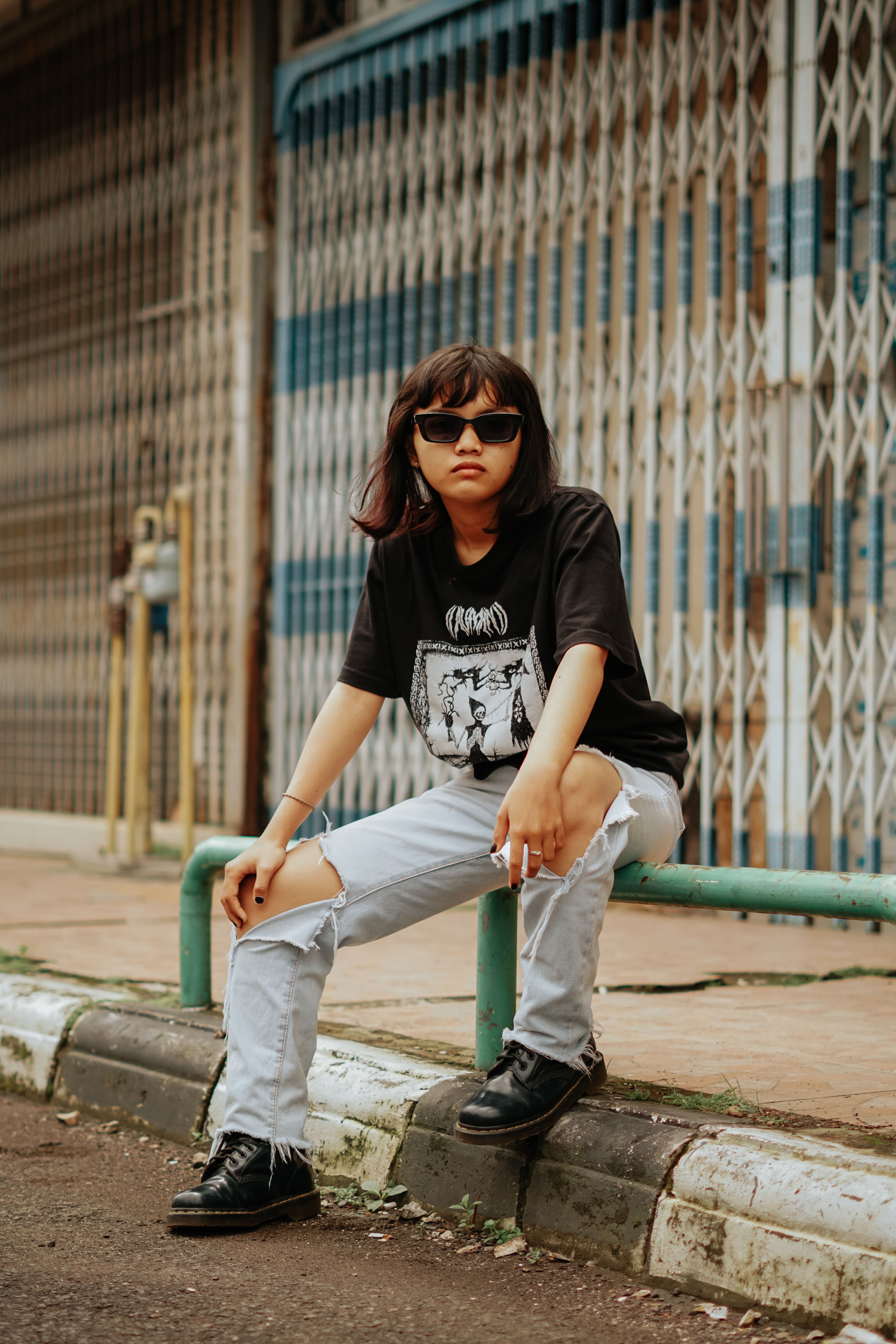 Woman in Black Crew Neck T-shirt Sitting on the Metal Railing · Free ...