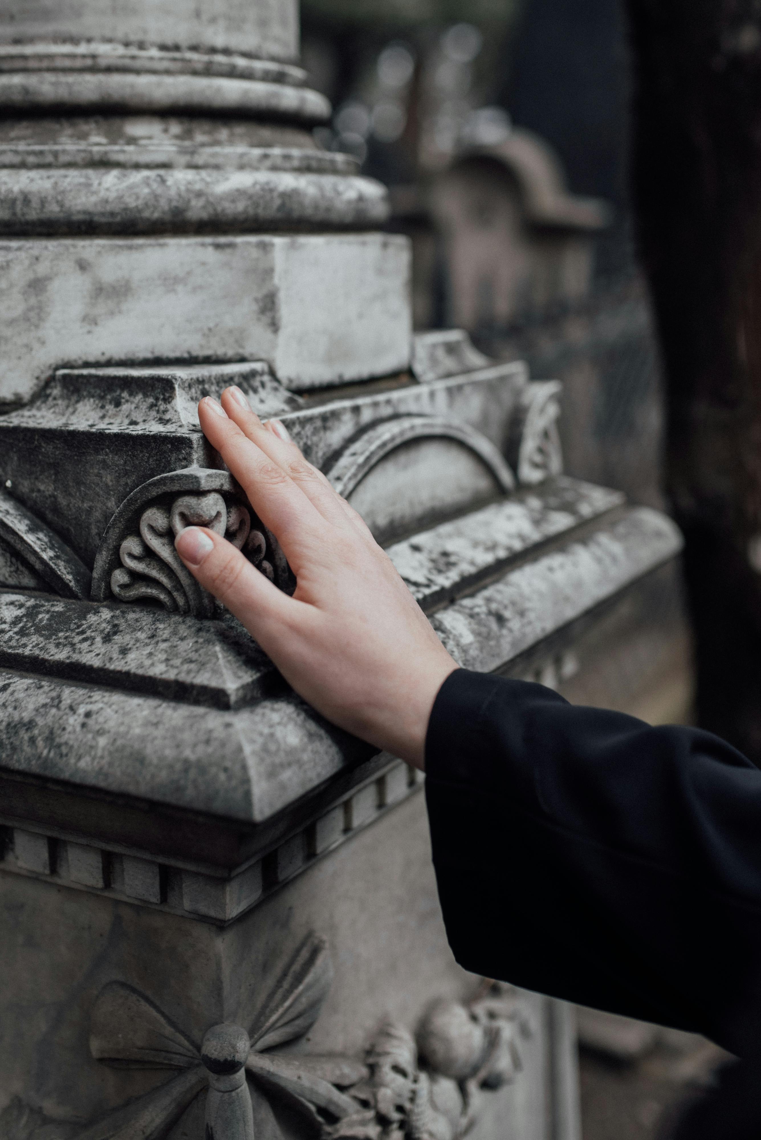 A Person Touching a Concrete Structure with Ornate Design · Free Stock ...