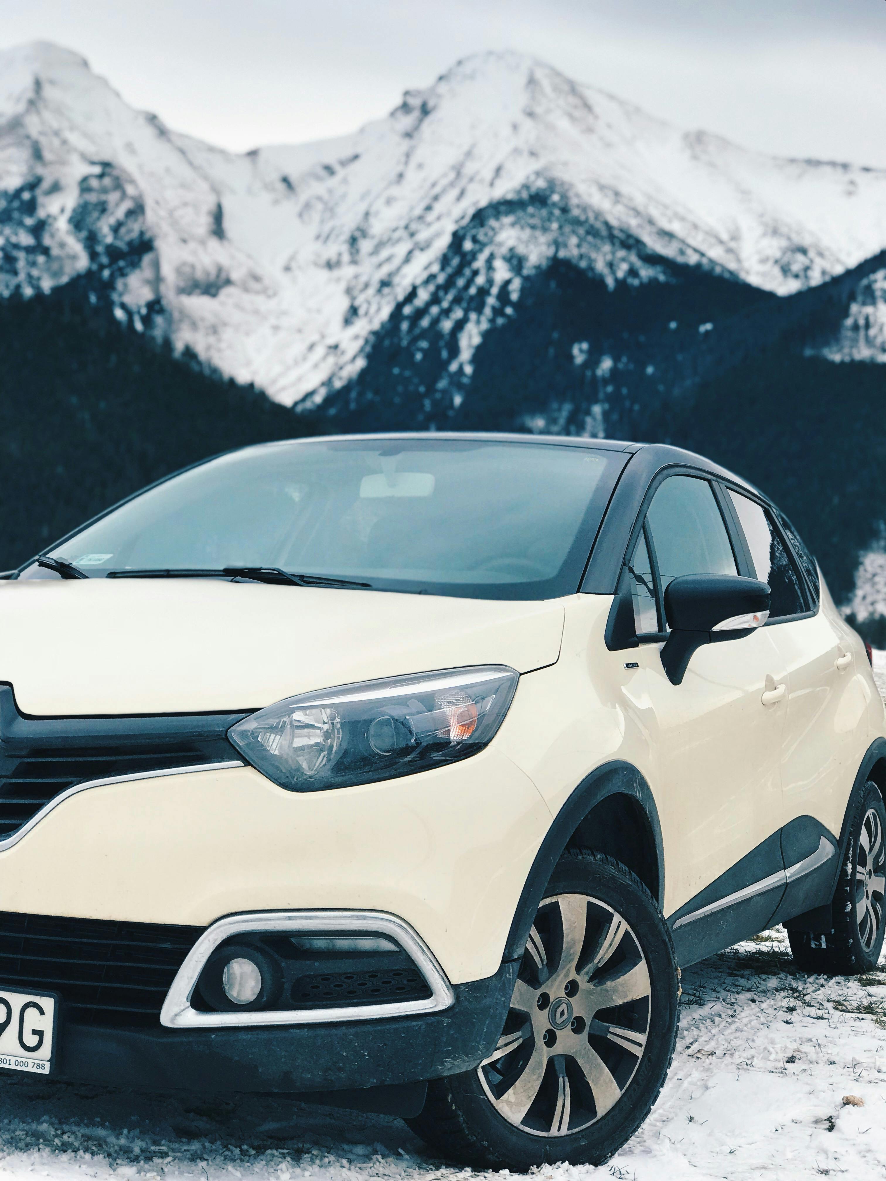White Renault Clio 4 on Snow Covered Road · Free Stock Photo