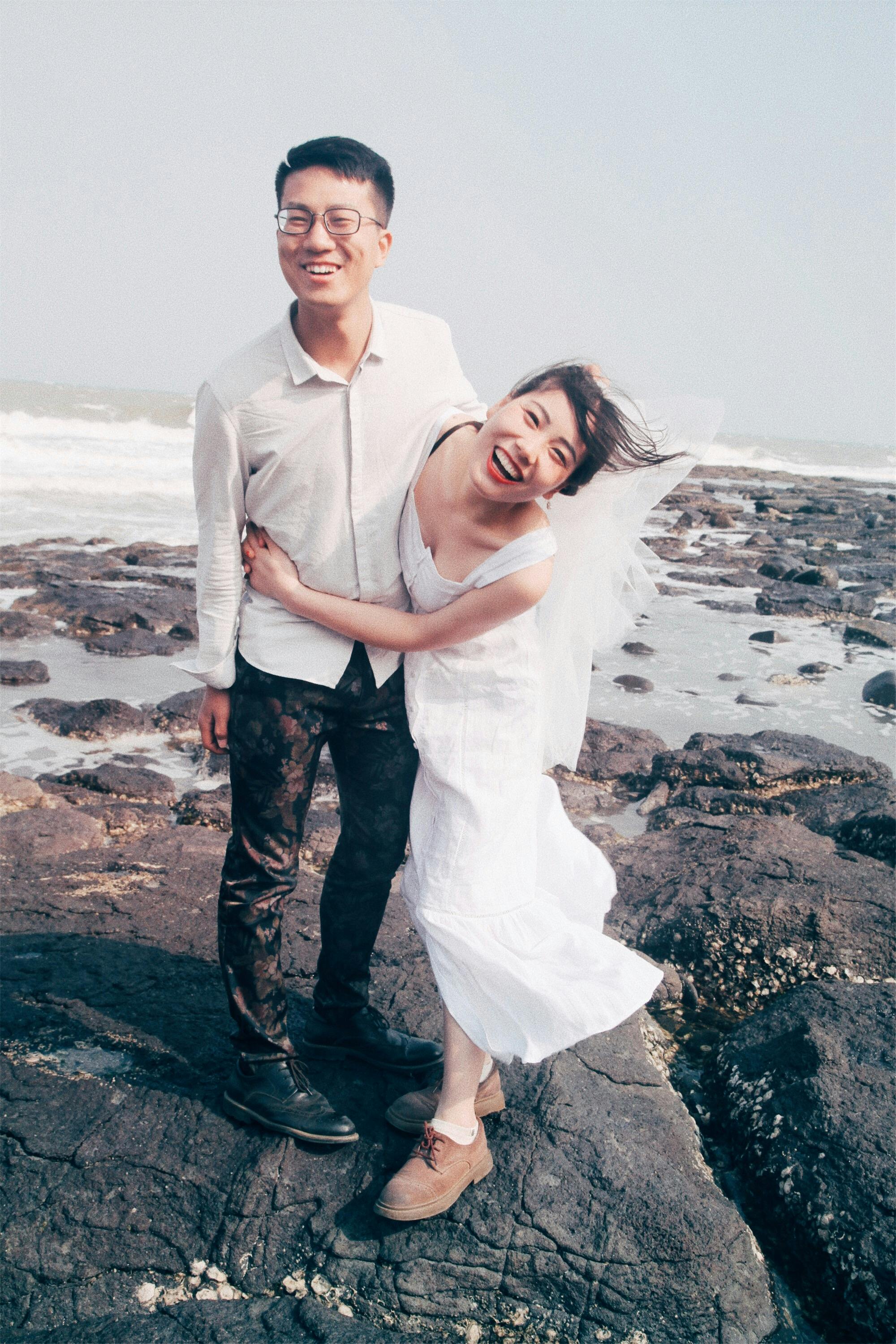 A Man Lifting a Woman on Concrete Pathway · Free Stock Photo