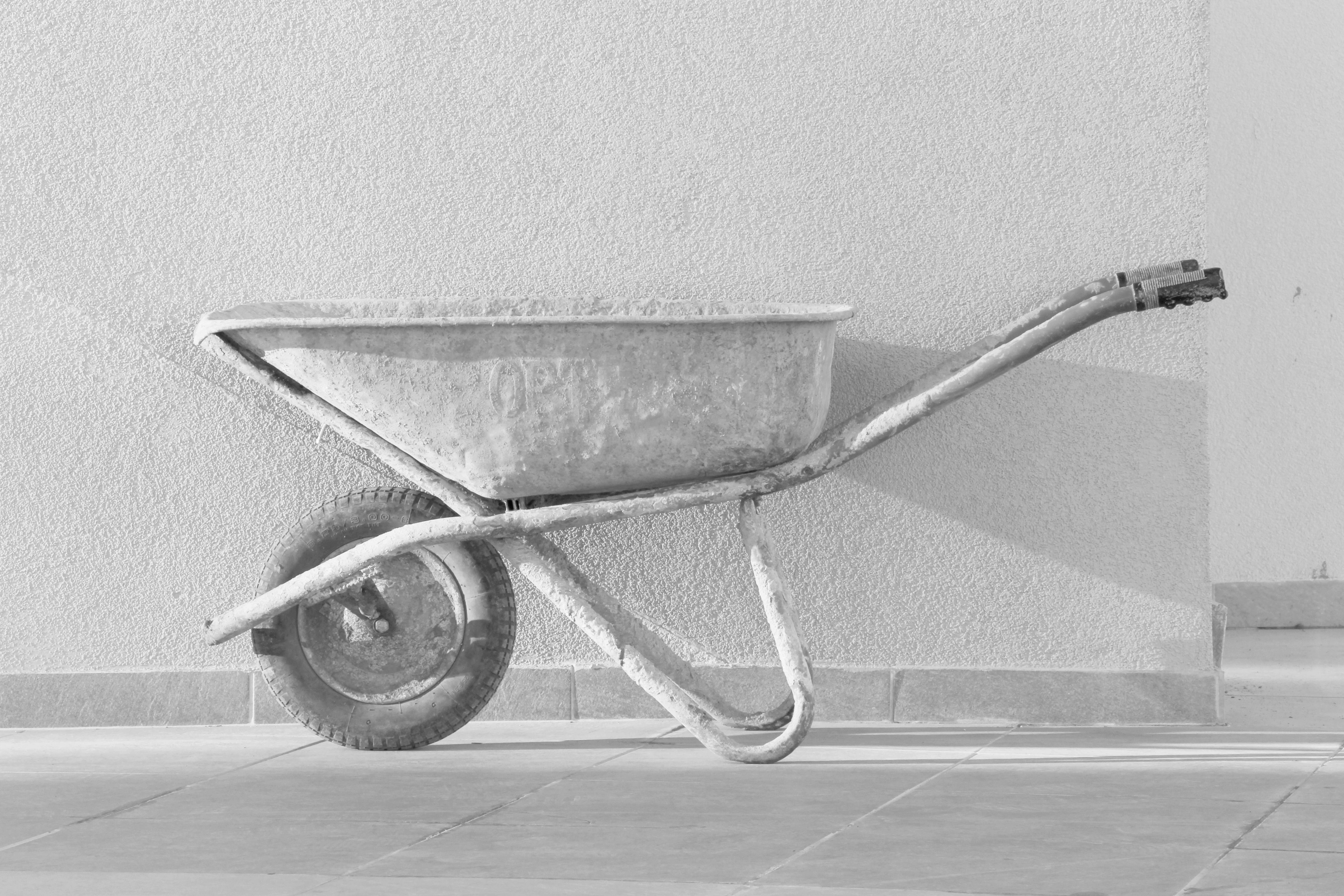 Grayscale Photo of a Wheelbarrow · Free Stock Photo