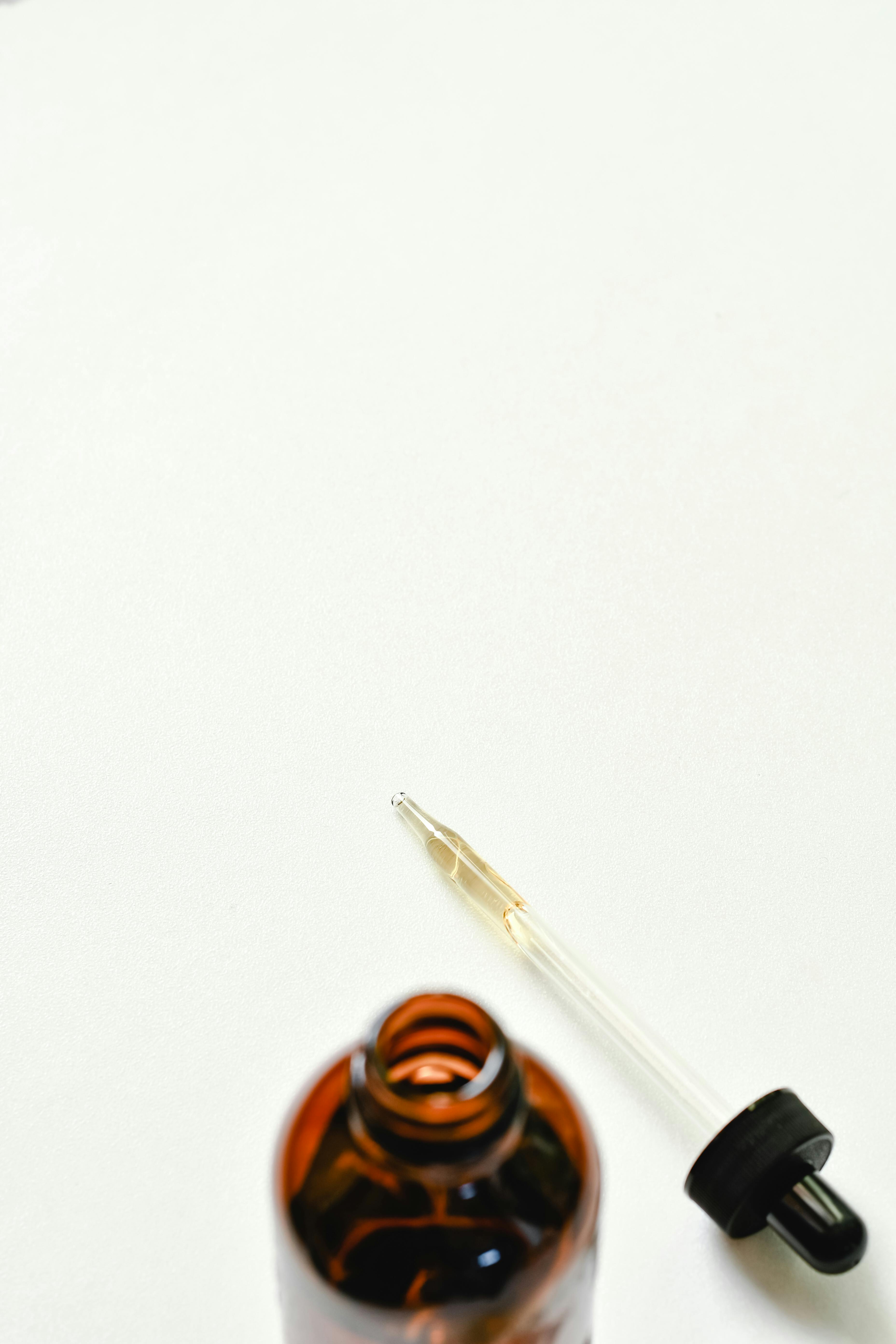 Photo of Dropper Near a Bottle · Free Stock Photo