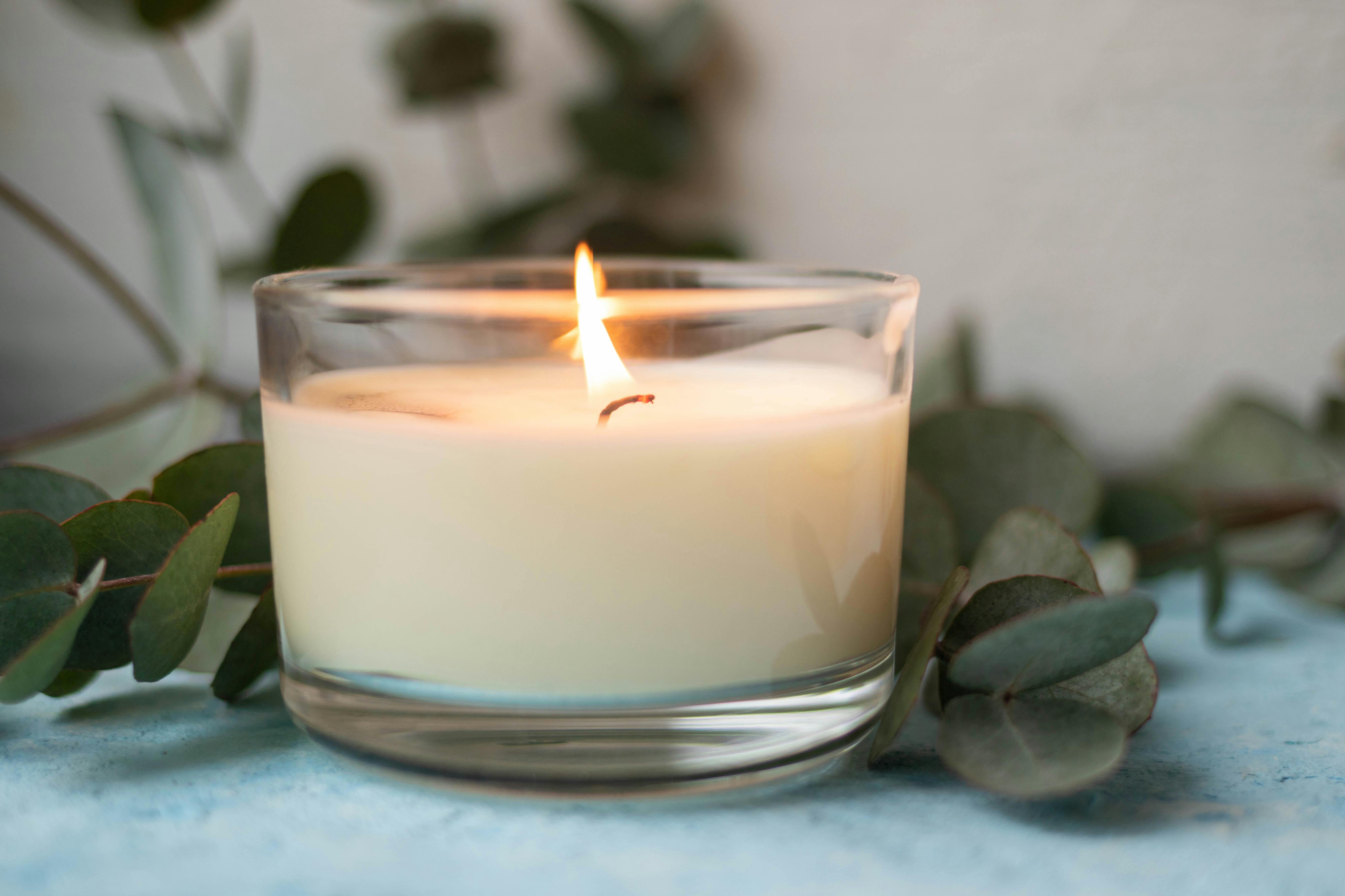 Close-Up Shot of a Lighted Candle in Clear Glass Holder · Free Stock Photo