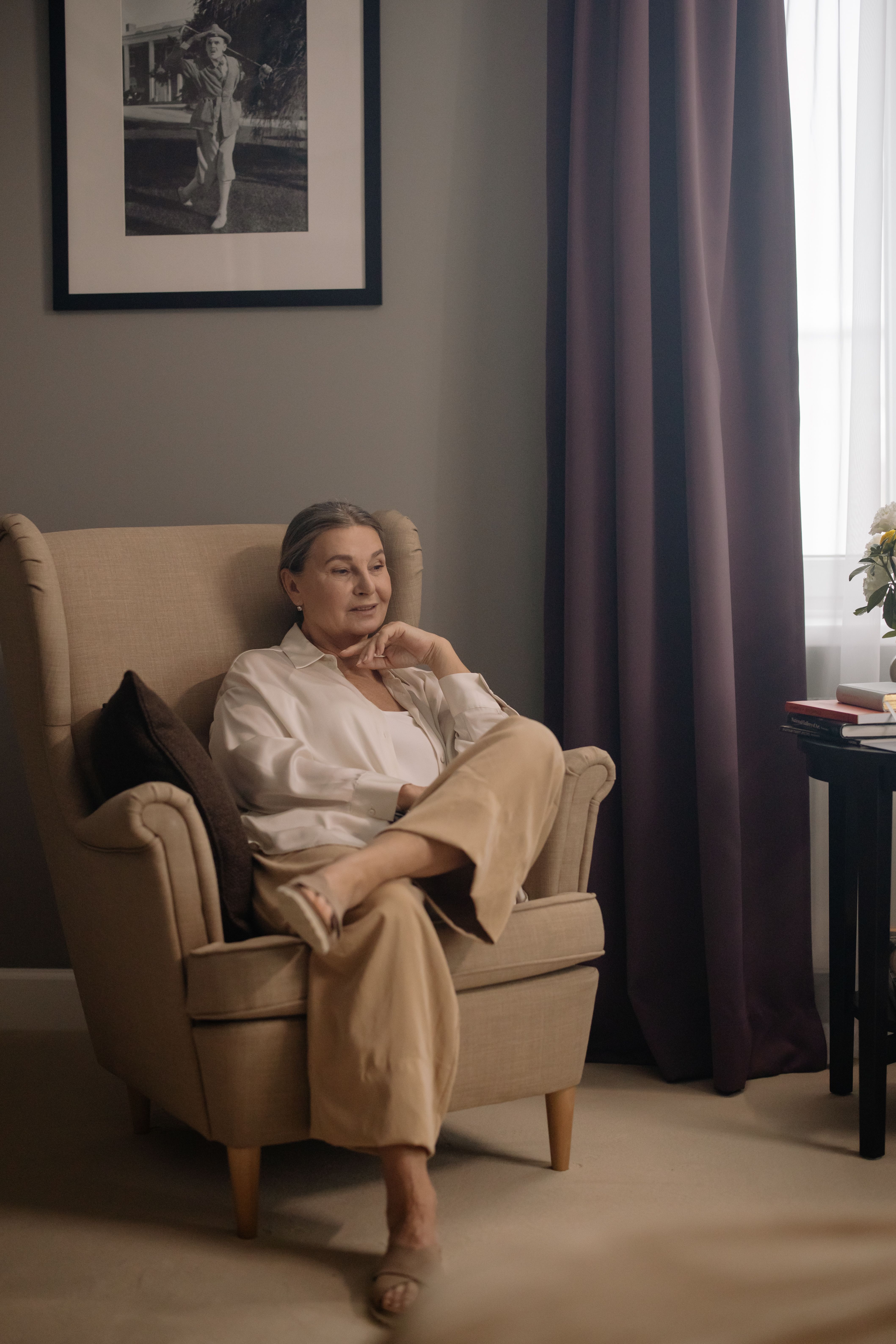 A Woman Sitting on Arm Chair · Free Stock Photo