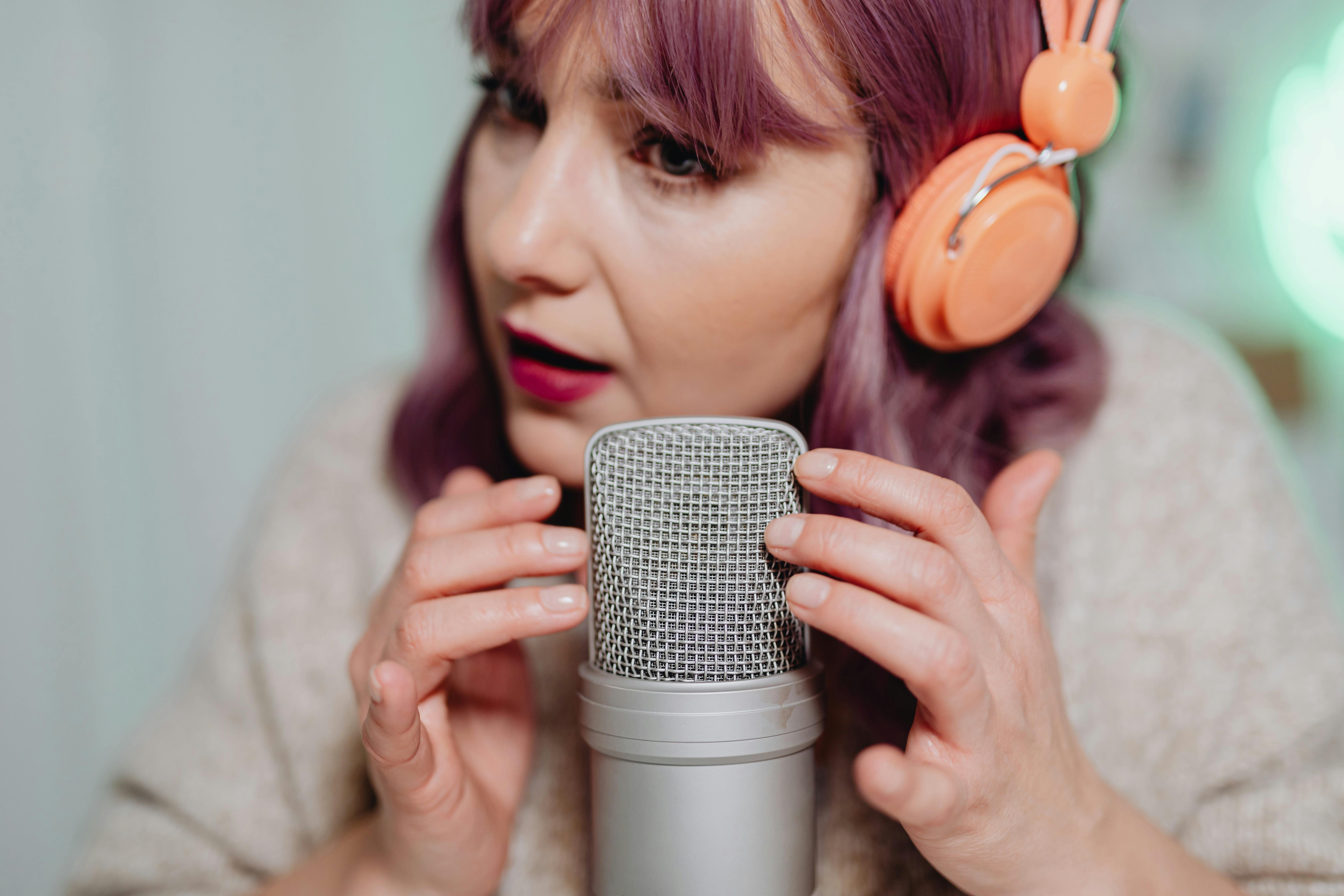 Photo of Woman Reading a Book While Wearing Headphones · Free Stock Photo