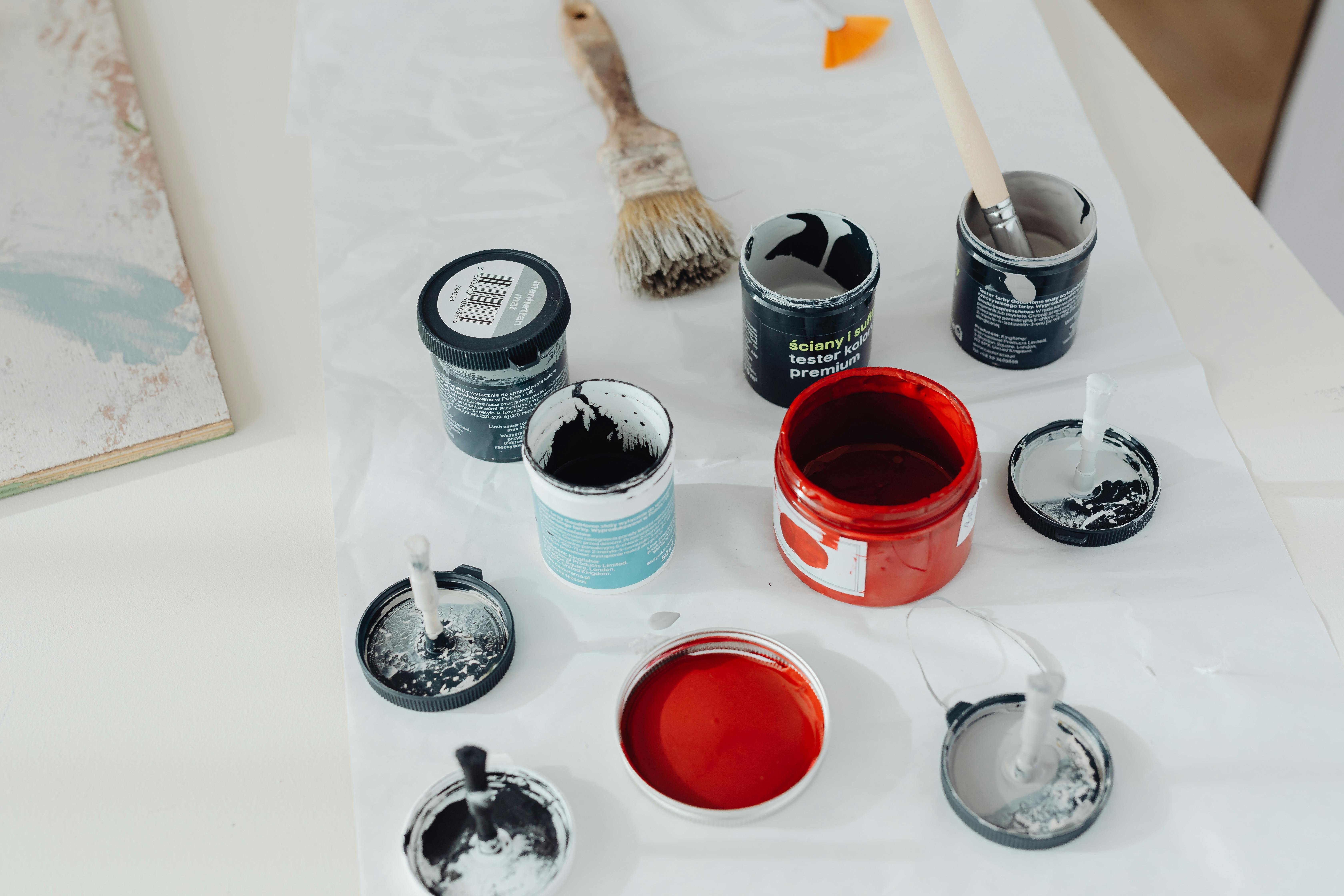 High-Angle Shot of Paint Cans on White Surface · Free Stock Photo