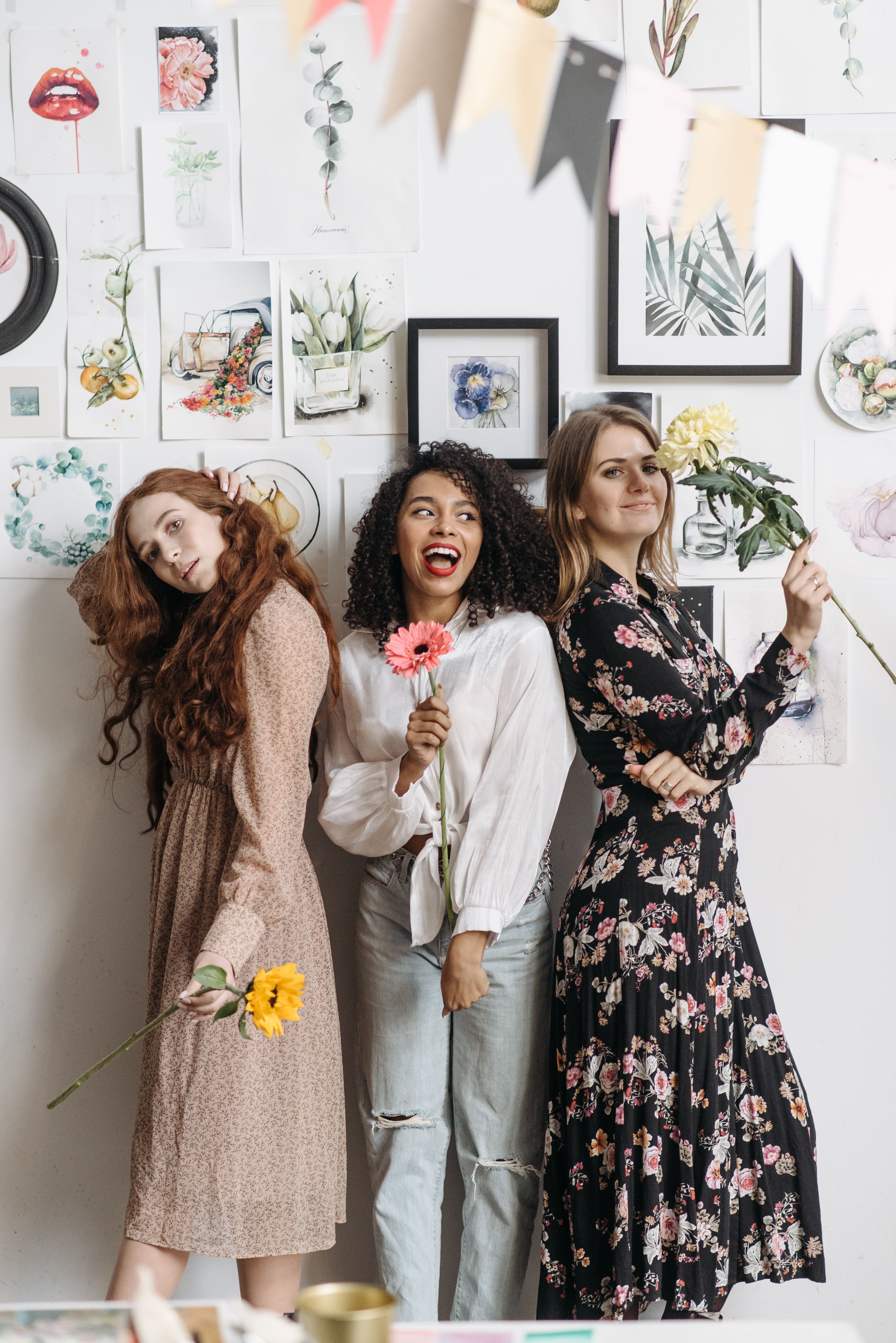 Women Standing Near White Wall · Free Stock Photo