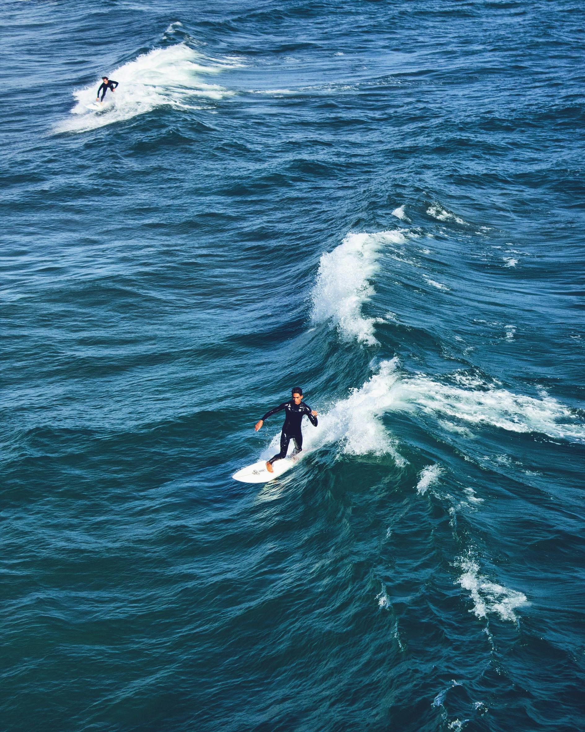 People Surfing in Blue Water · Free Stock Photo