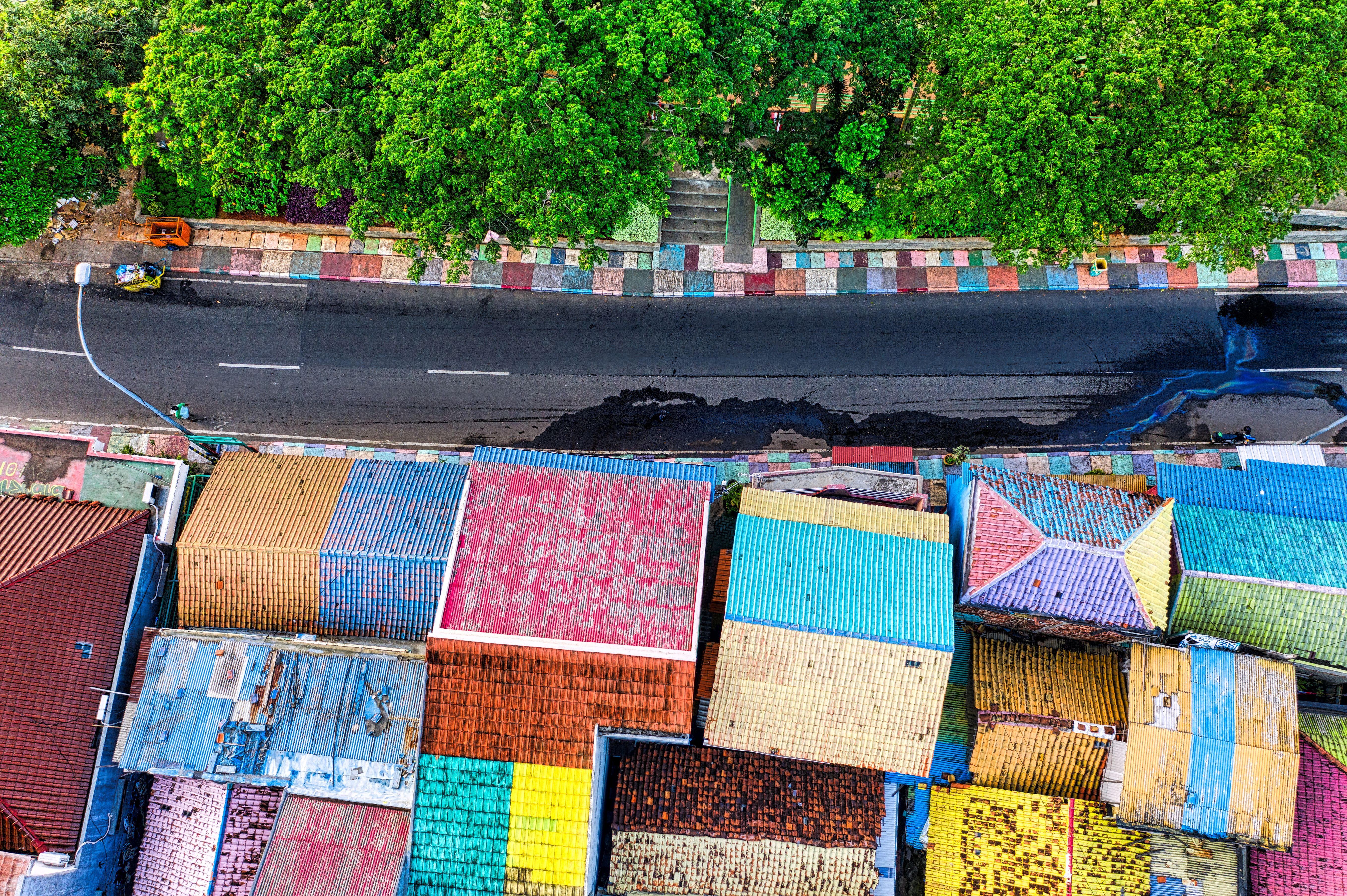 Top View of Multicoloured Roofs and a Road · Free Stock Photo