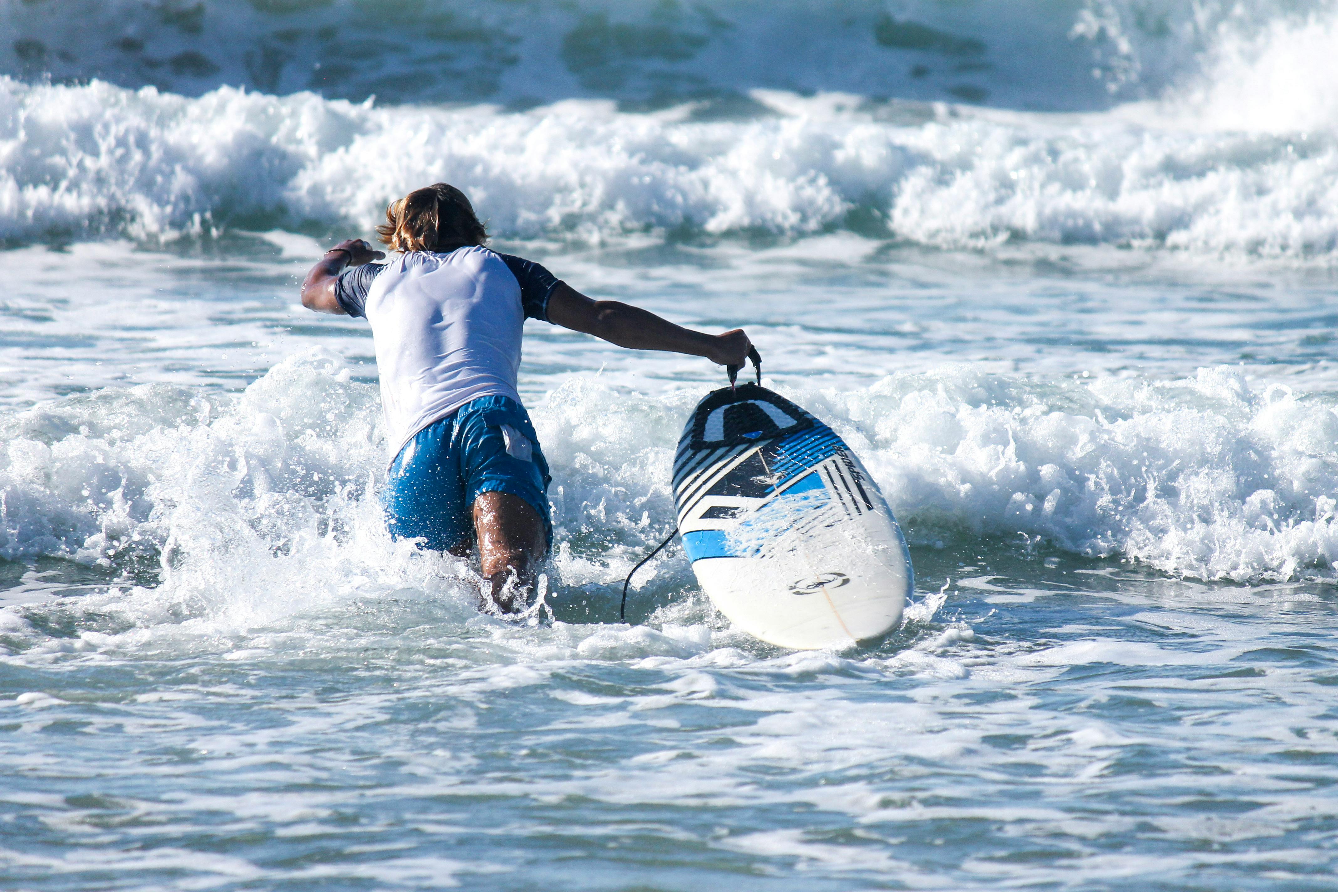 A Person Surfing on the Beach · Free Stock Photo