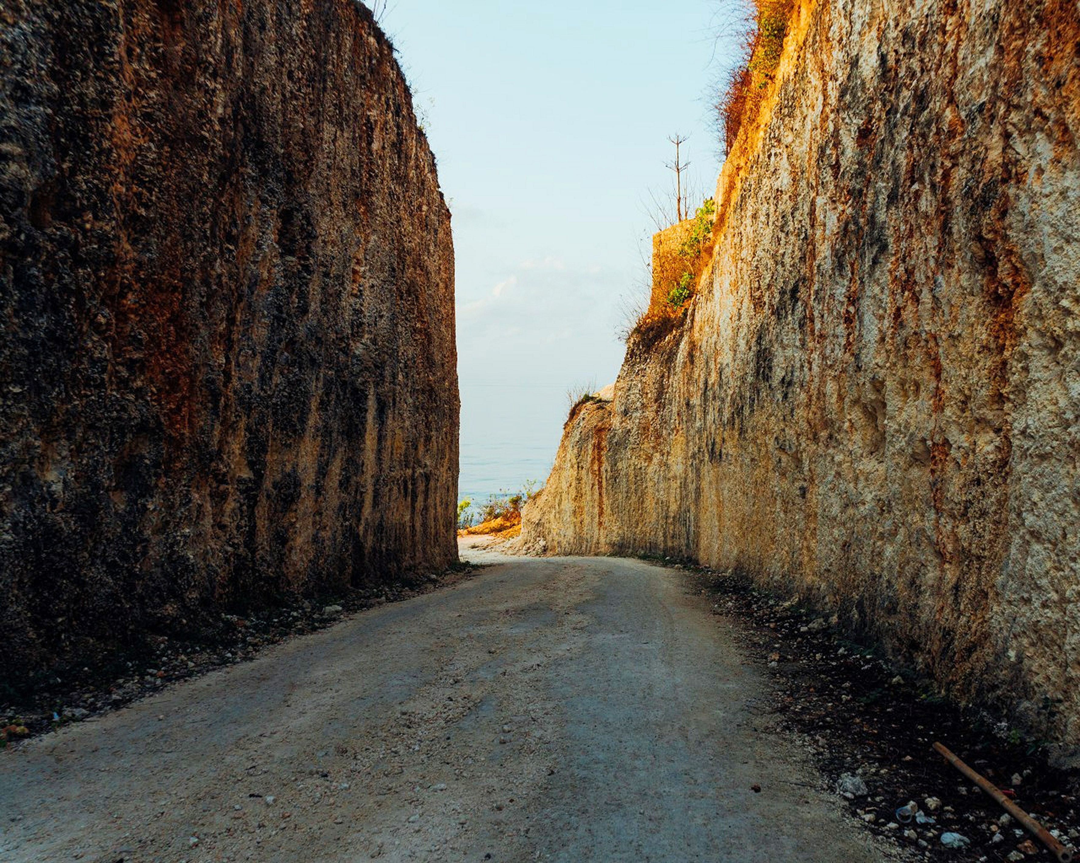 Narrow Road Between Cliffs Leading to the Beach · Free Stock Photo