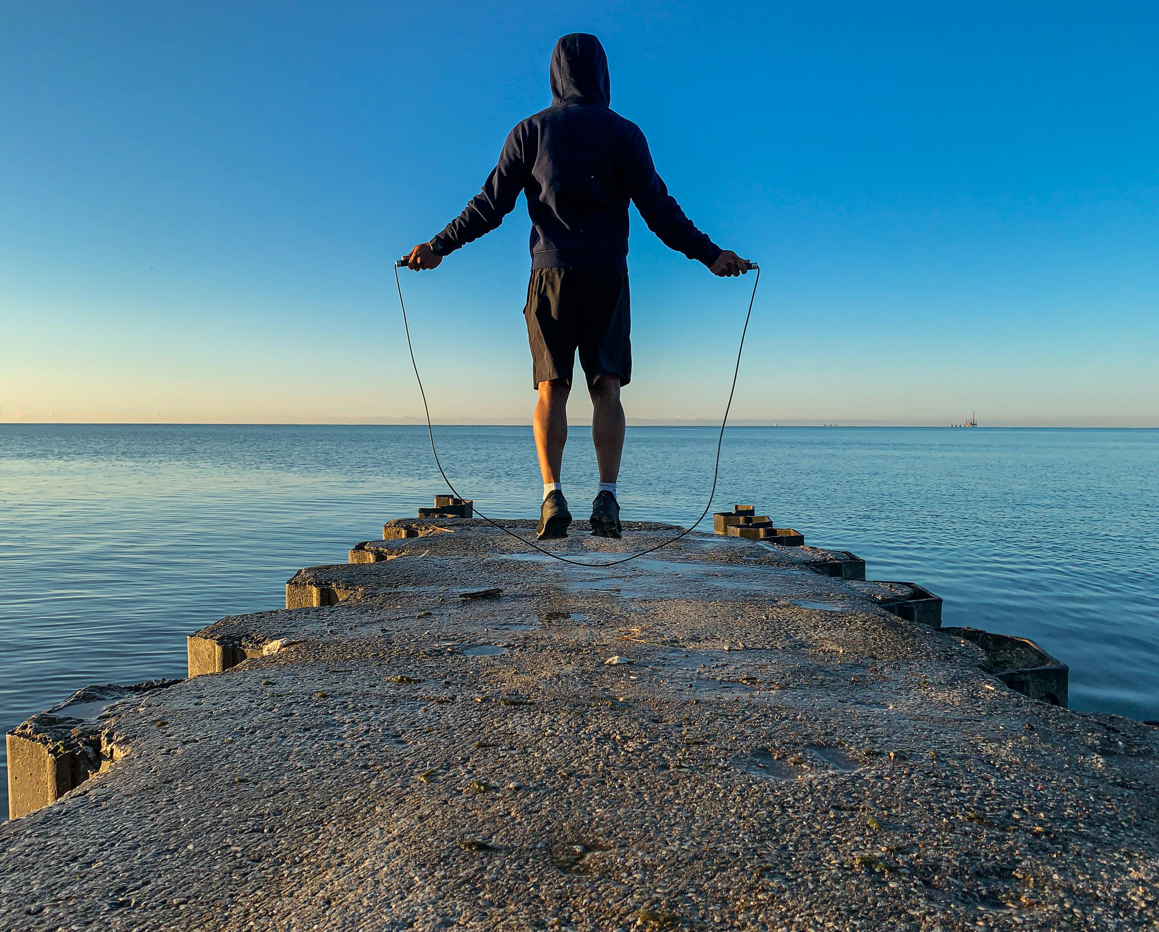 A Man in Black Jacket Doing Jump Rope · Free Stock Photo
