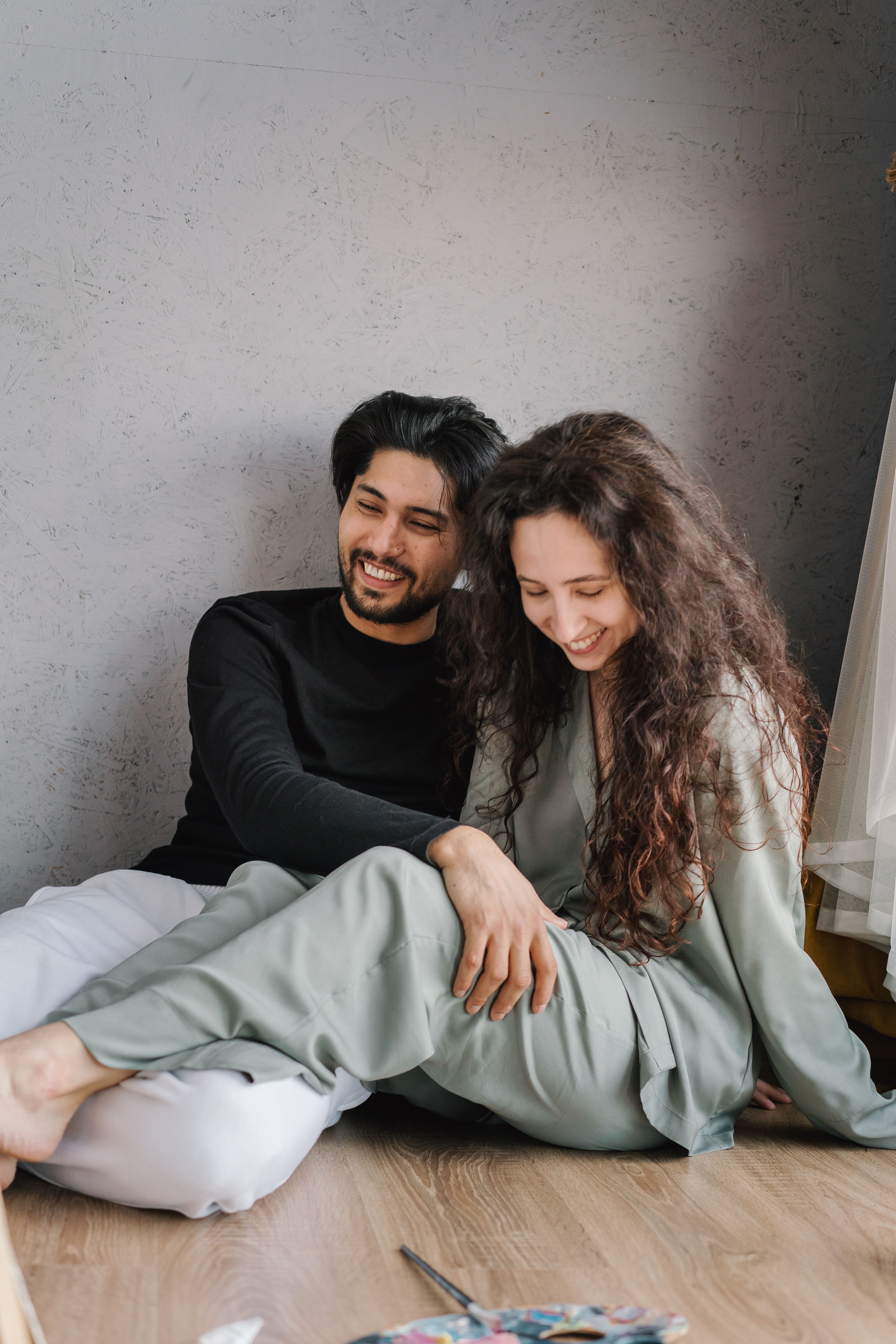 Photo of a Couple Sitting while Smiling · Free Stock Photo
