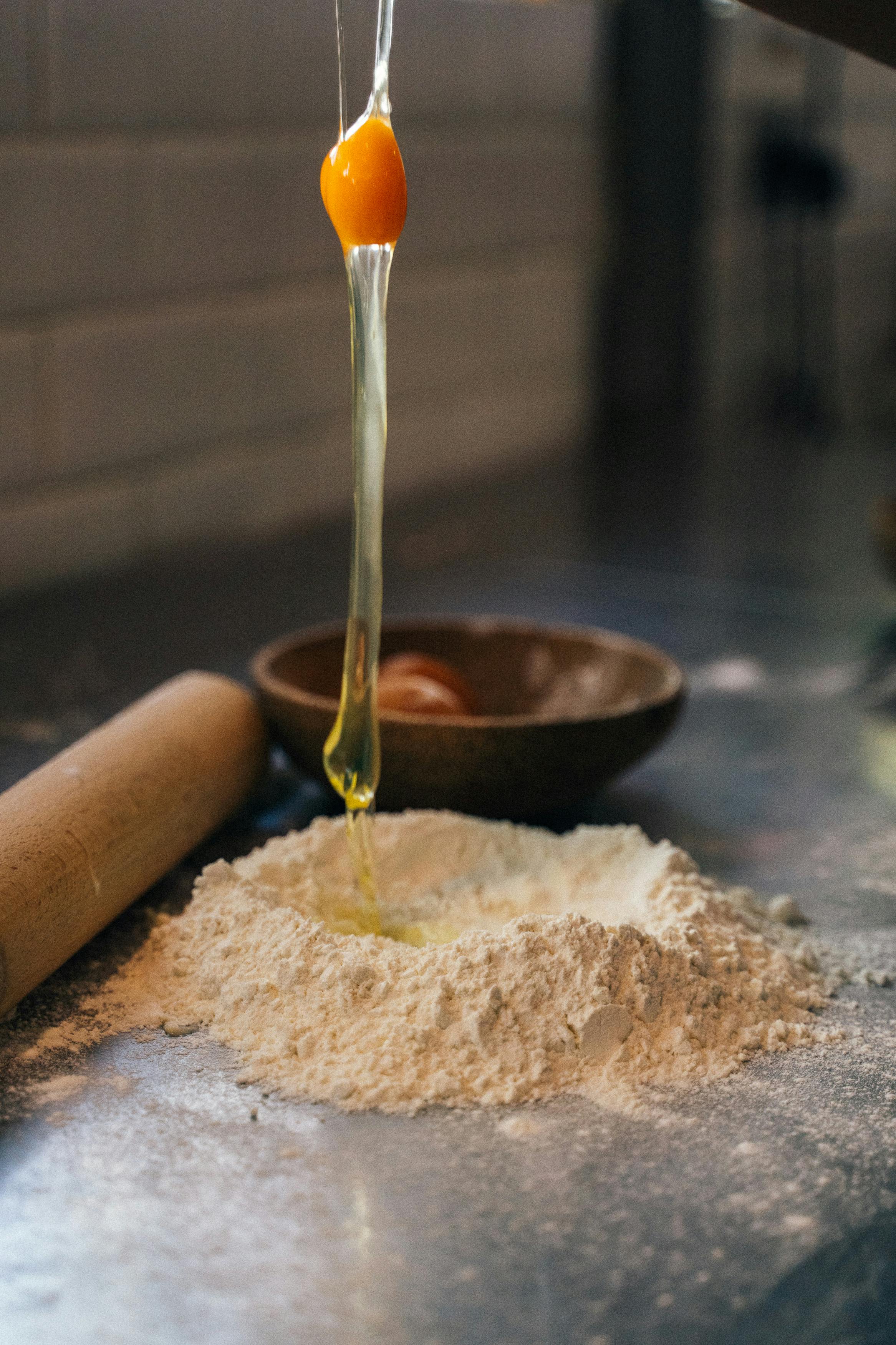 An Egg Falling on the Flour · Free Stock Photo