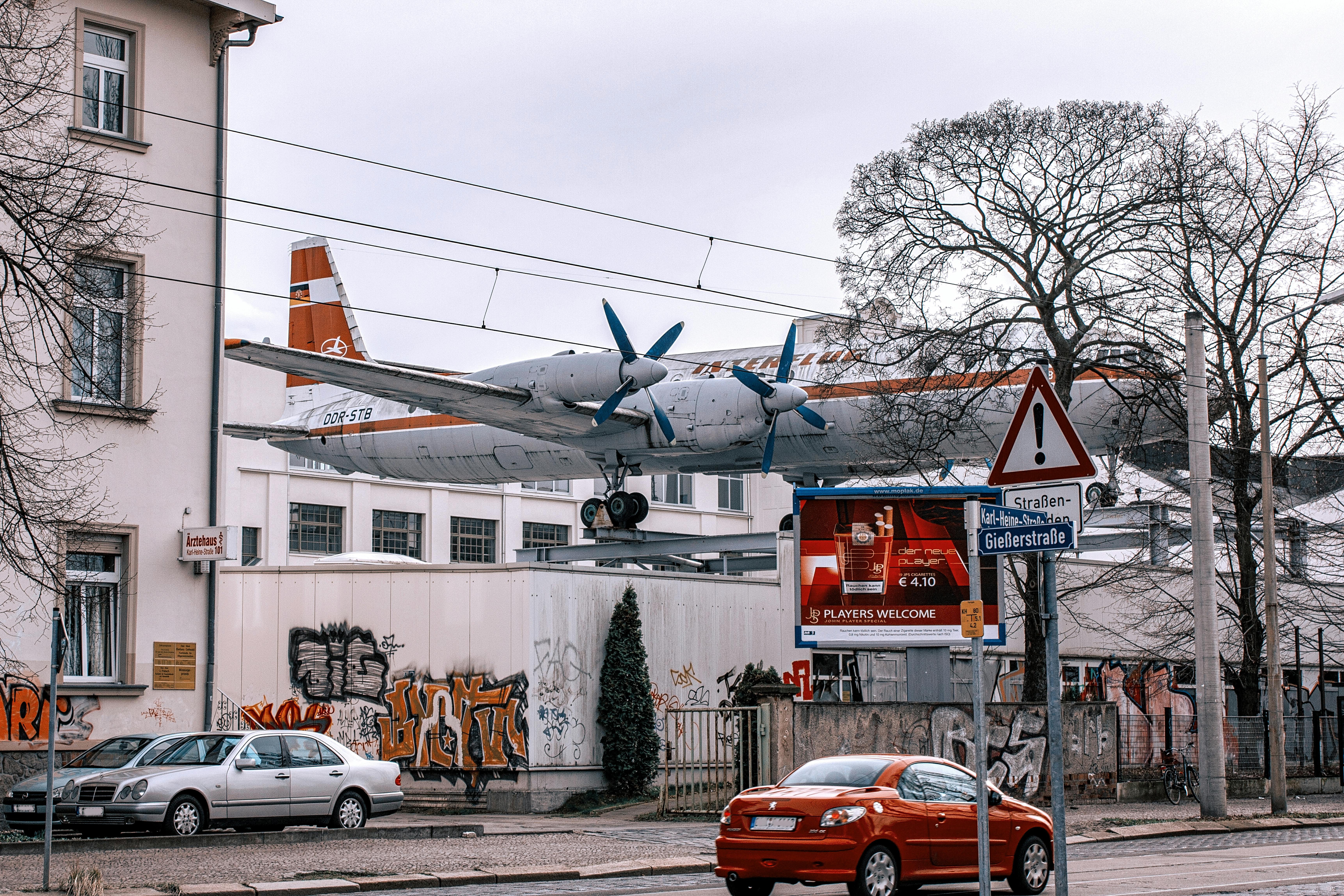 Airplane over Wall and Street in Leipzig · Free Stock Photo