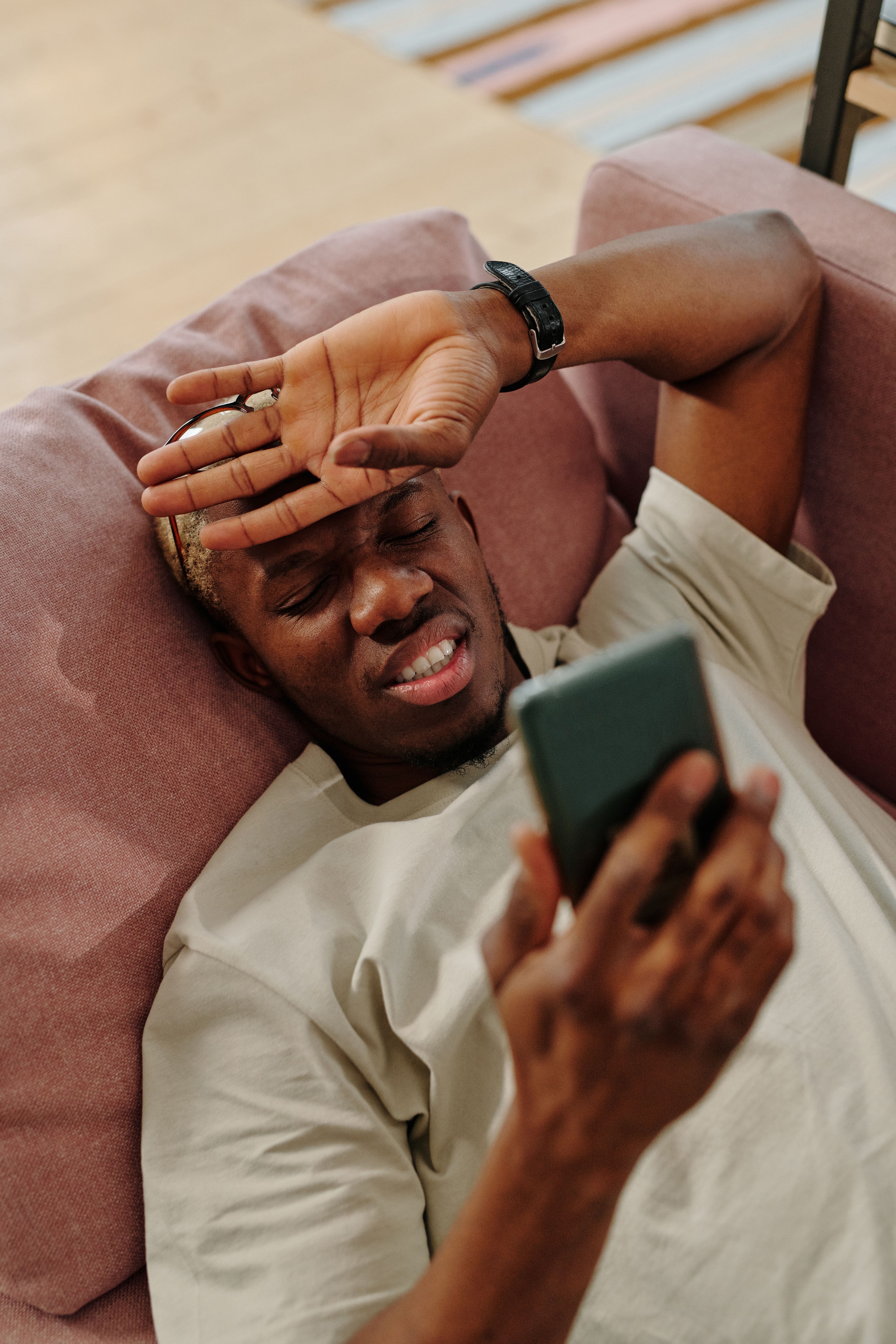 Overhead Shot of a Man Holding a Smartphone while Lying Down · Free ...