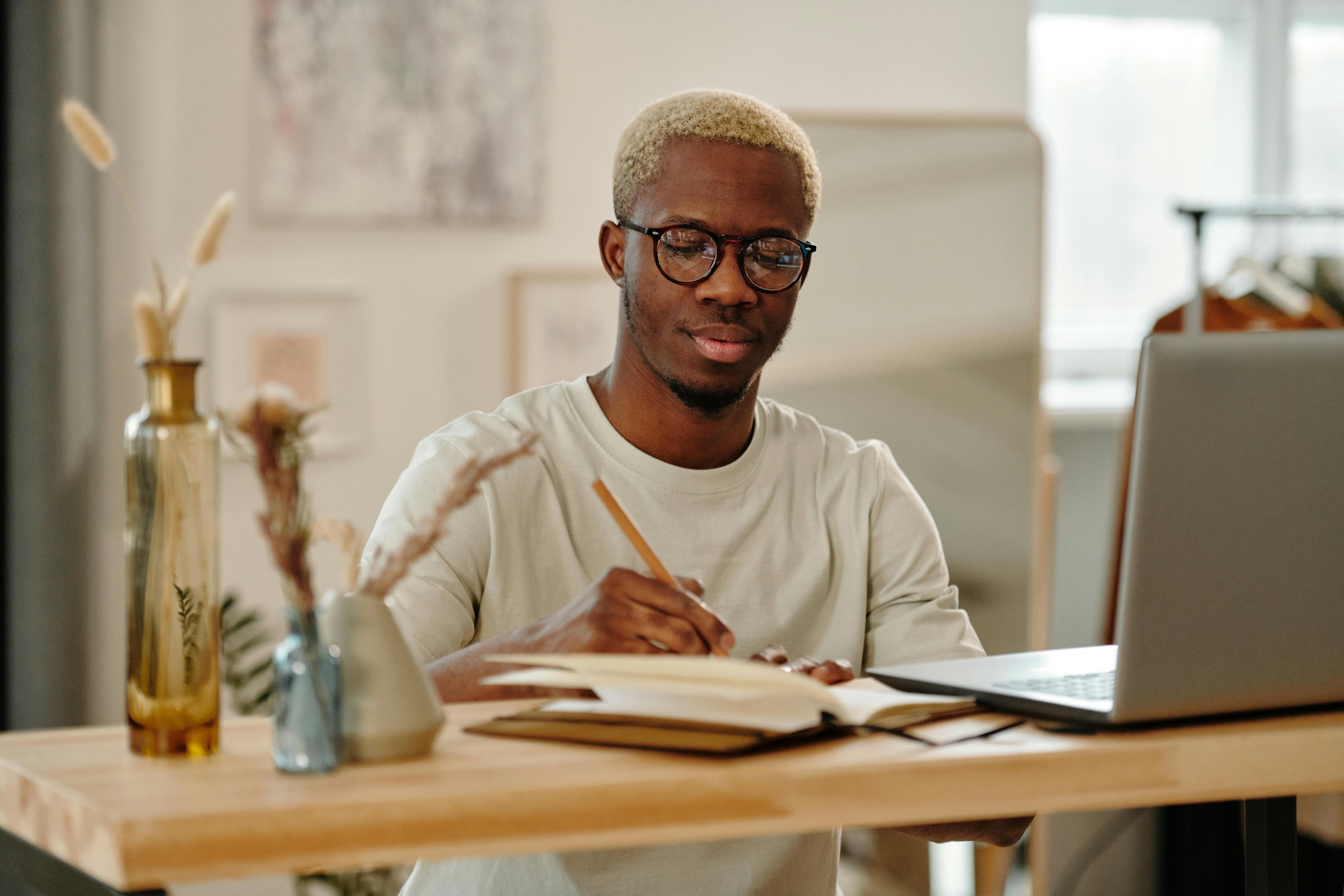 Man in White Shirt Writing on White Paper · Free Stock Photo