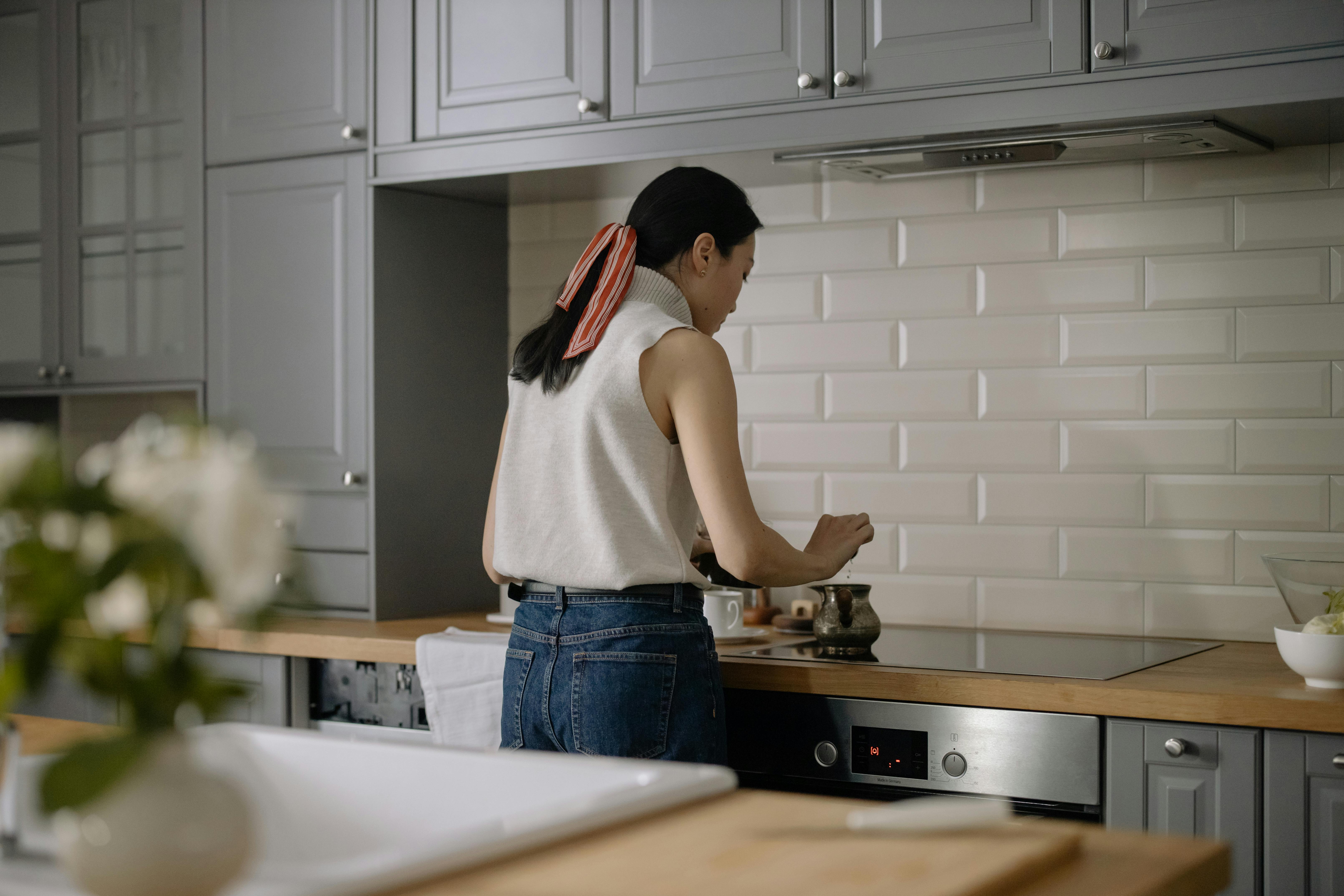 Back View of Woman in Kitchen · Free Stock Photo