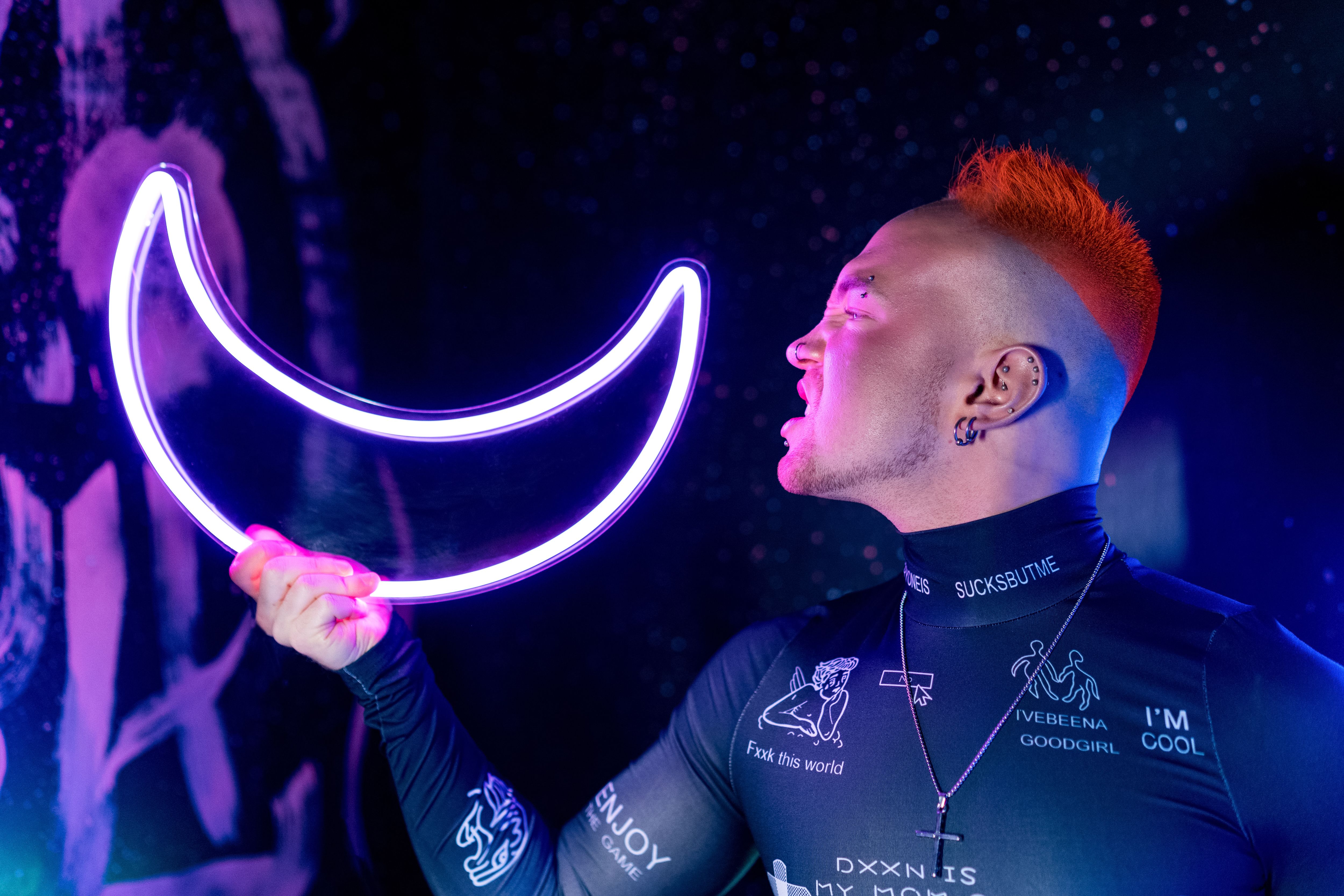 Man Holding a Moon Neon Light · Free Stock Photo