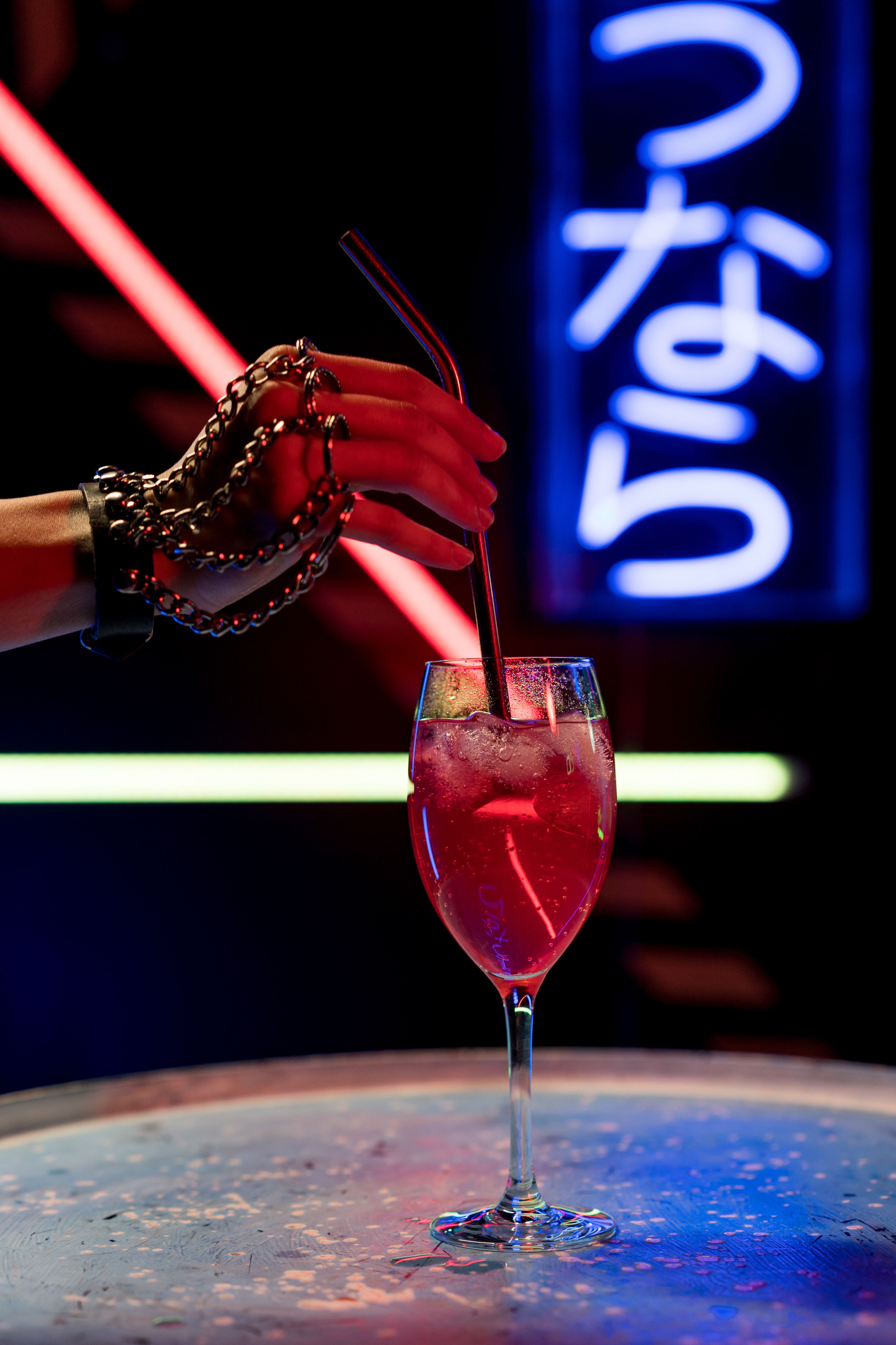 A Person Holding a Drinking Straw from a Wine Glass · Free Stock Photo