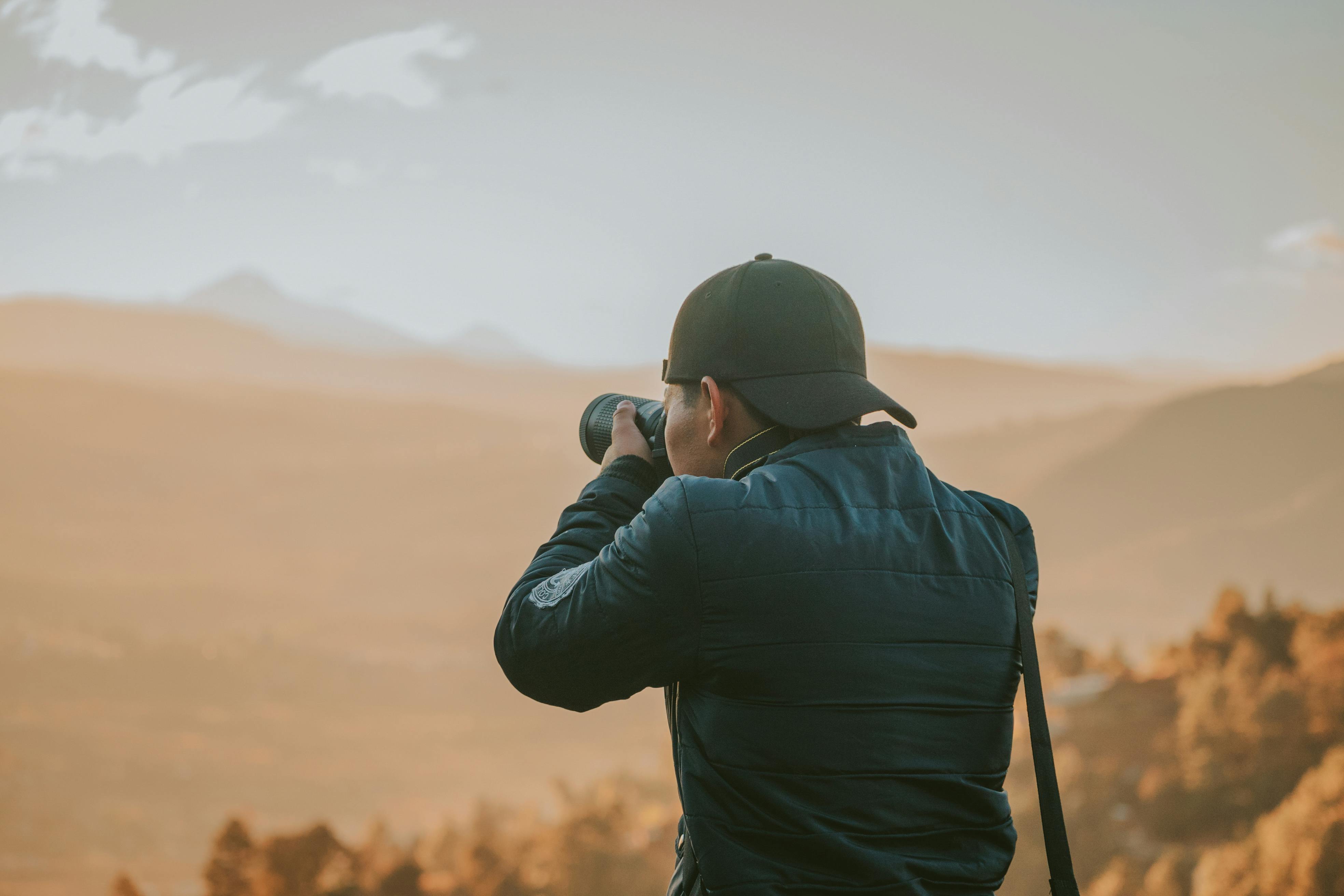 Man Carrying Cameras · Free Stock Photo