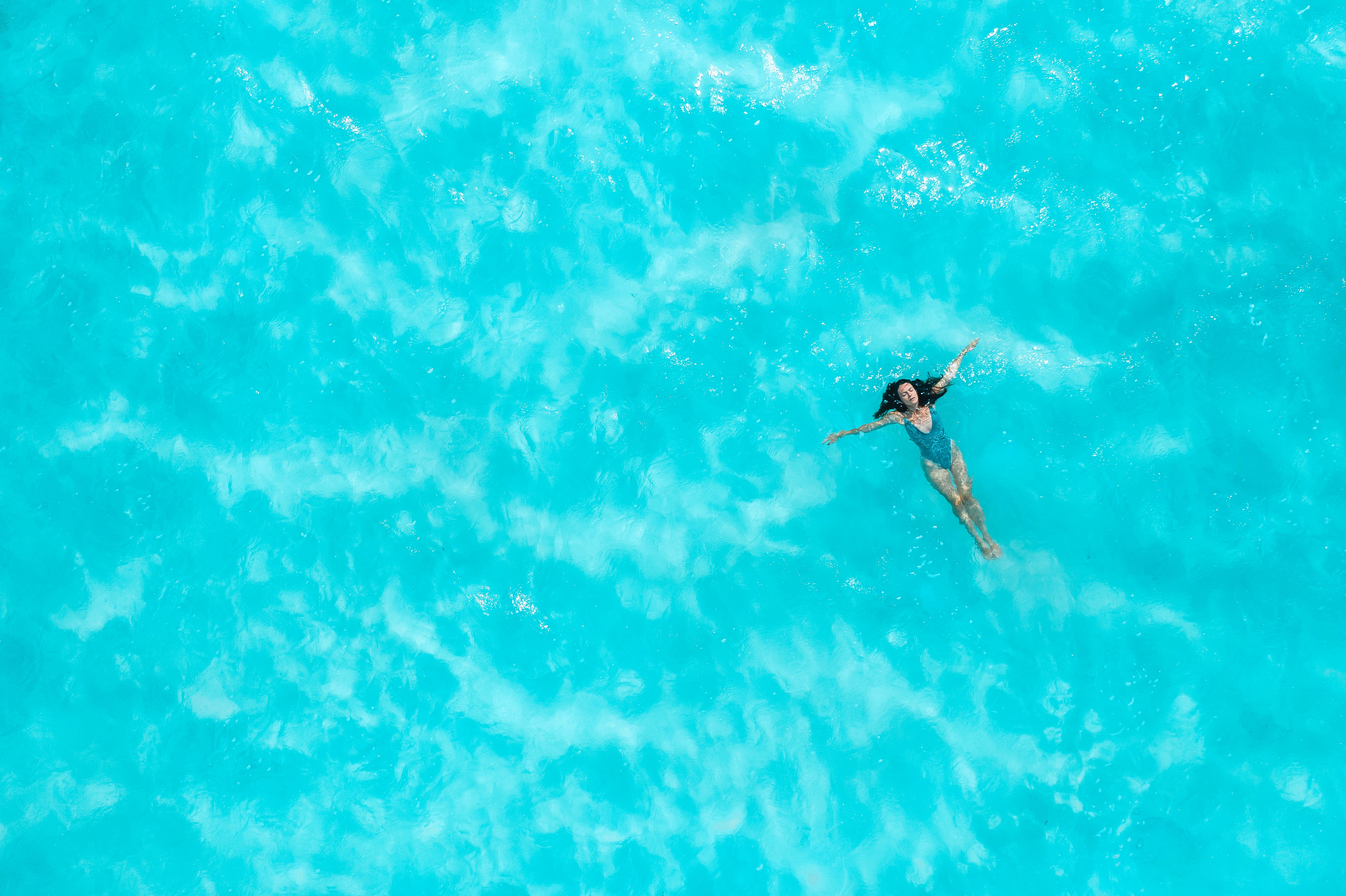 Aerial Photo of a Woman Floating in the Ocean · Free Stock Photo