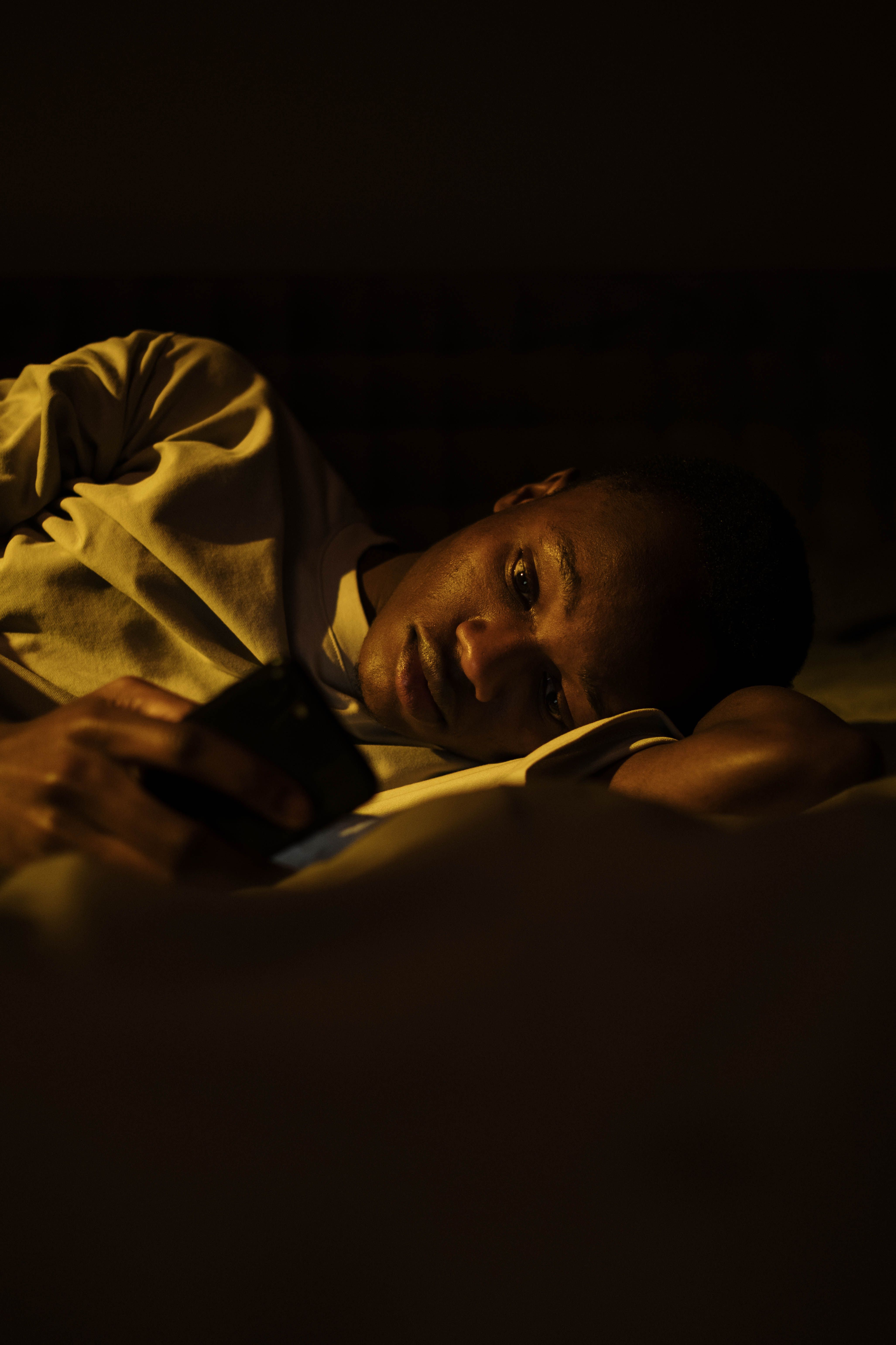 A Man Sitting Inside a Dark Room · Free Stock Photo