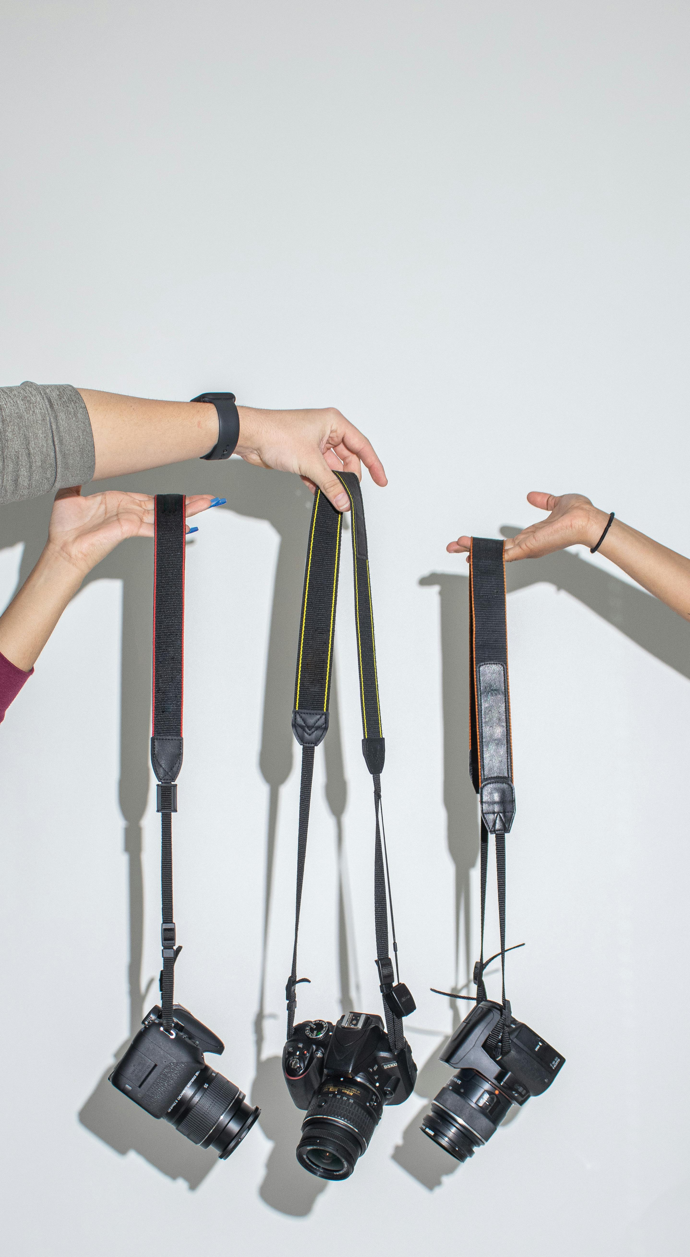 People Holding Camera Straps · Free Stock Photo