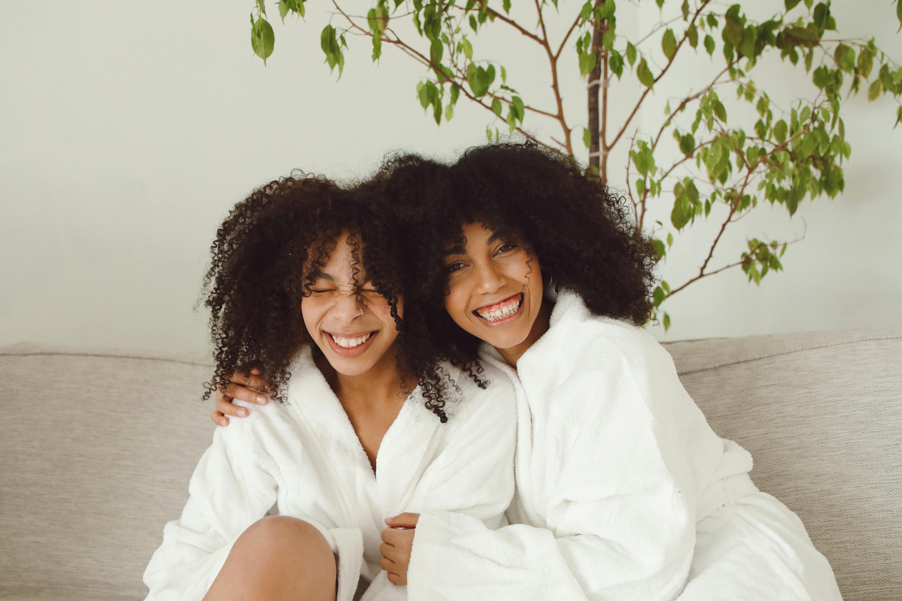 Smi8ling Women Wearing White Robes · Free Stock Photo