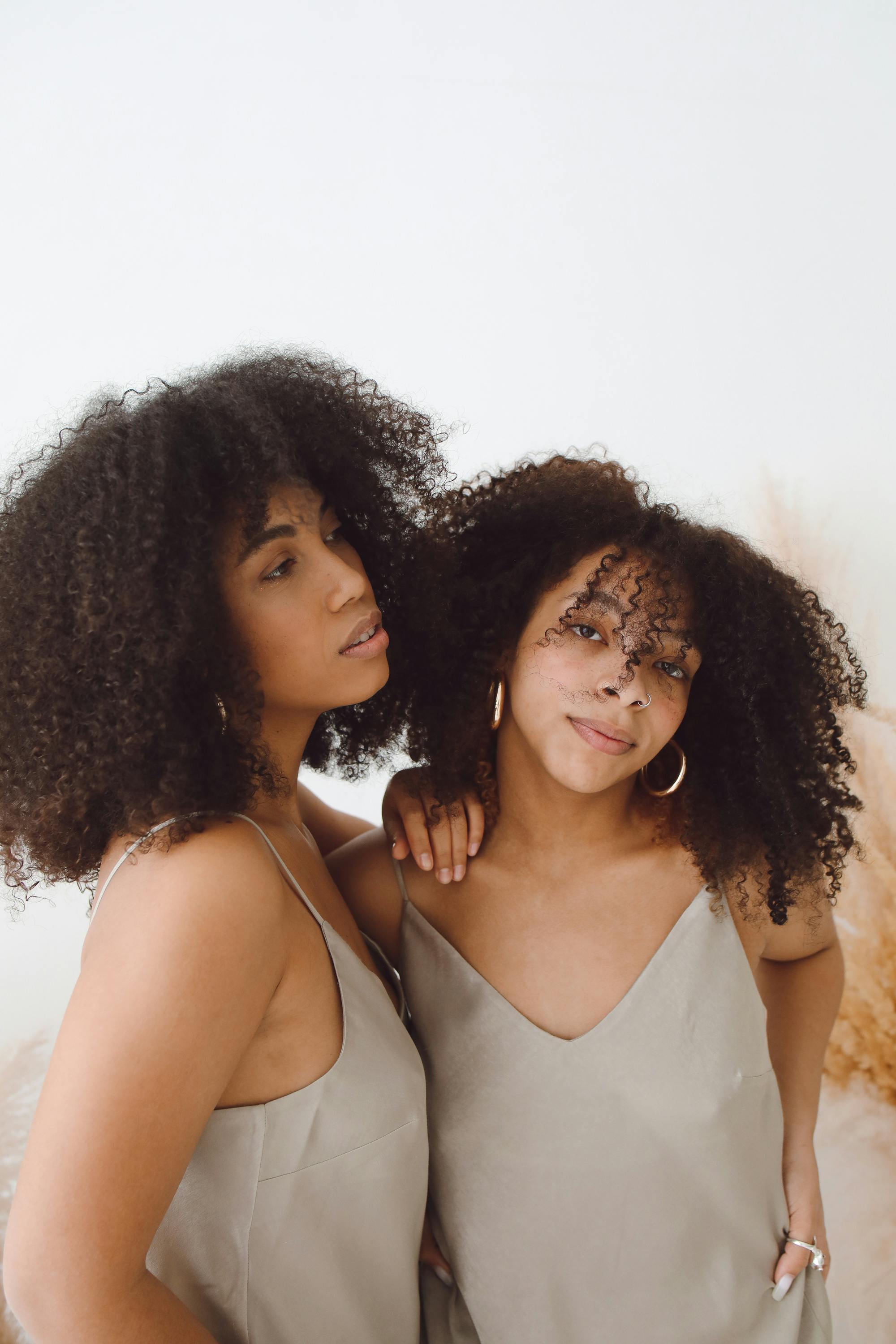 Women in Spaghetti Strap Top Posing Together · Free Stock Photo