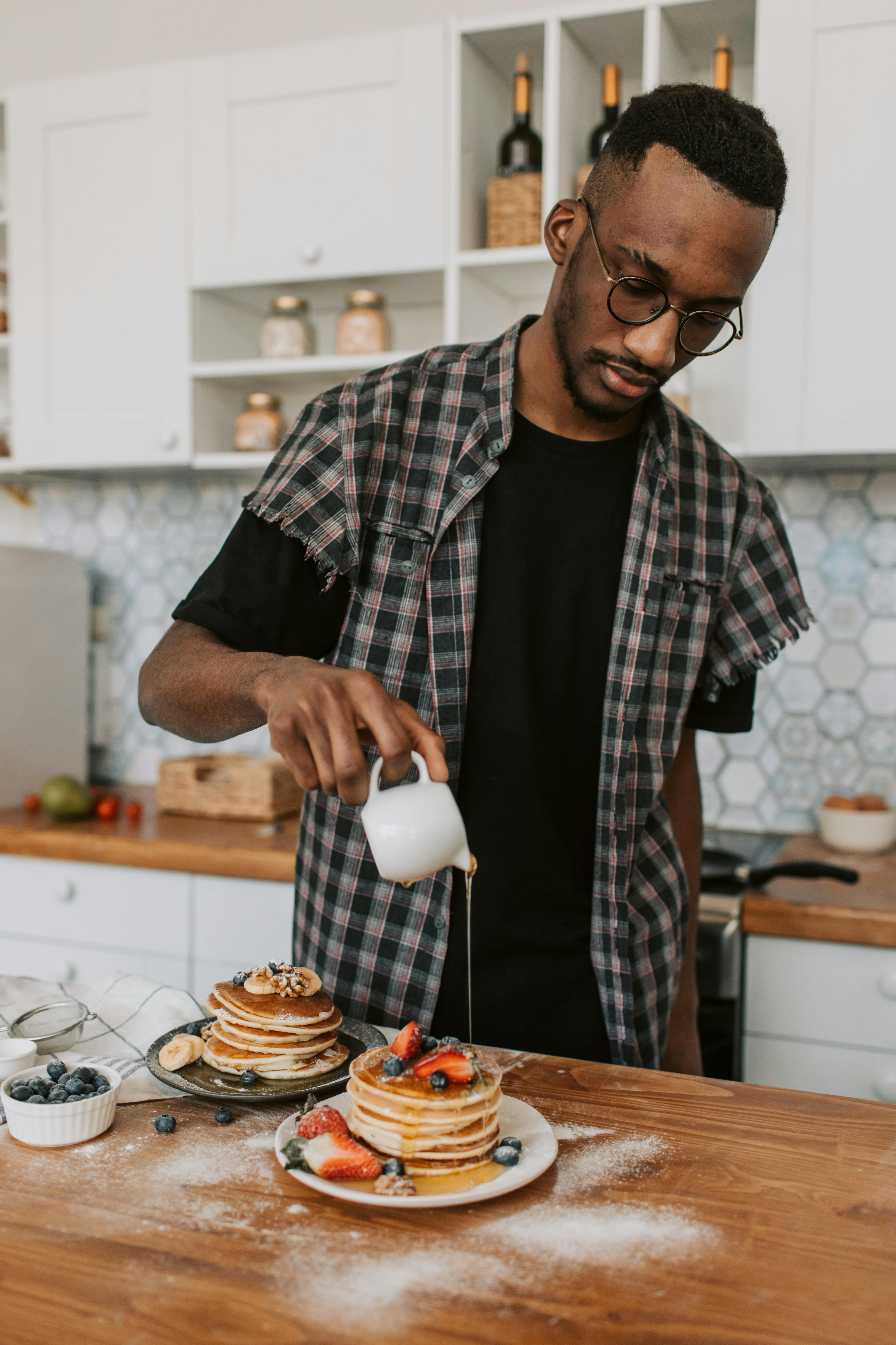 Person Pouring Syrup on Pancake · Free Stock Photo