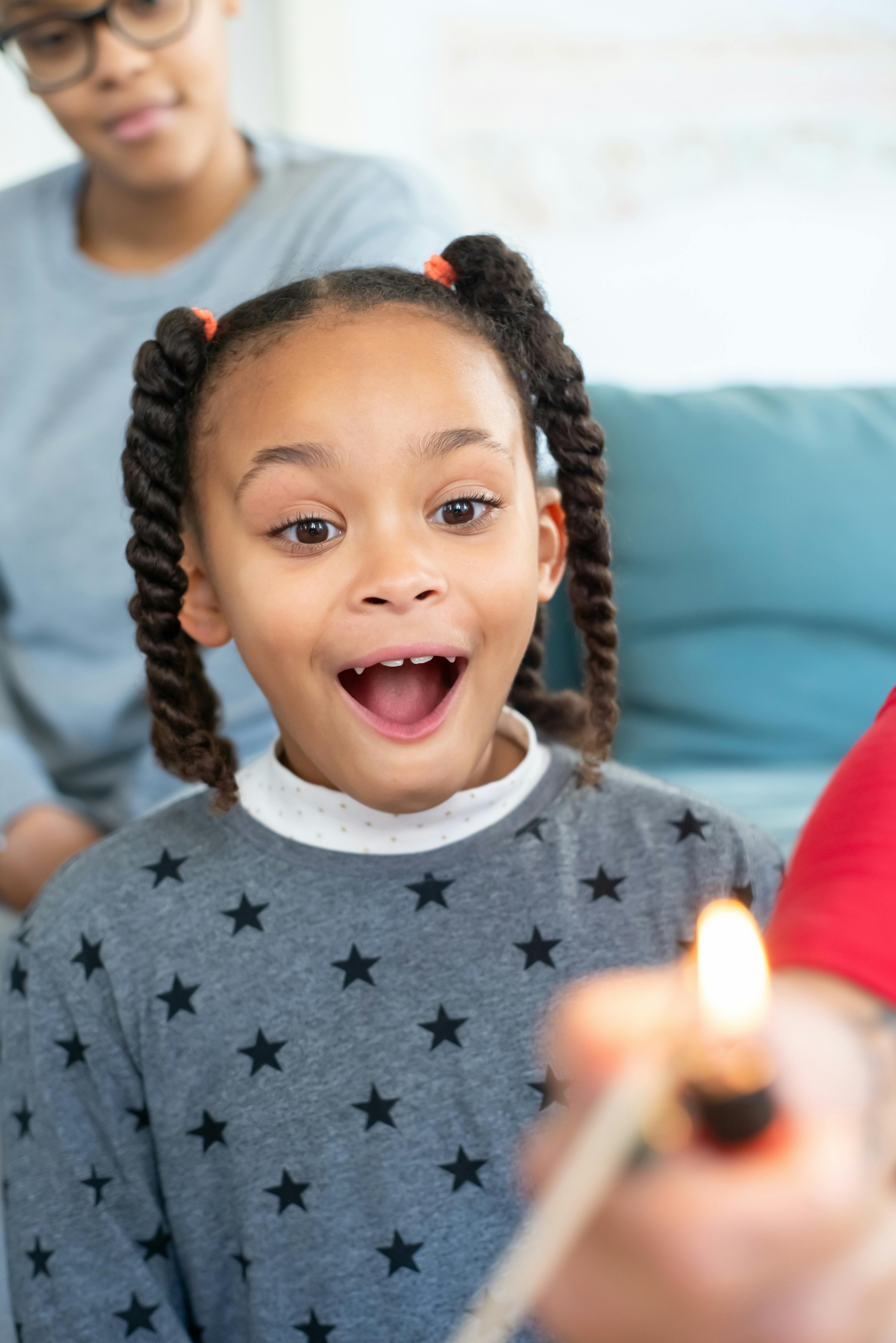 Happy and Excited Little Girl Looking at Person Using a Lighter · Free ...