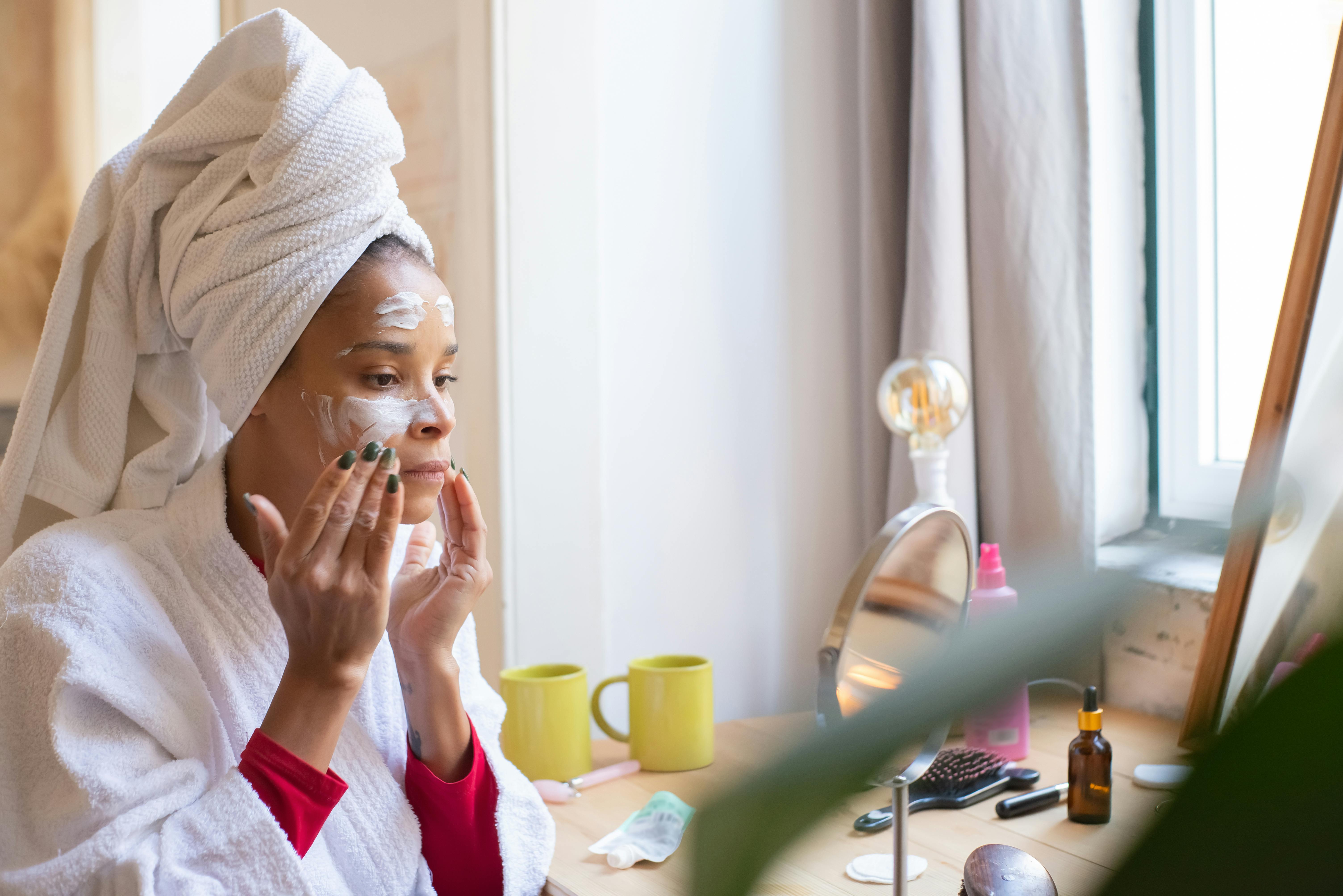 A Woman Applying Facial Cream on Face · Free Stock Photo
