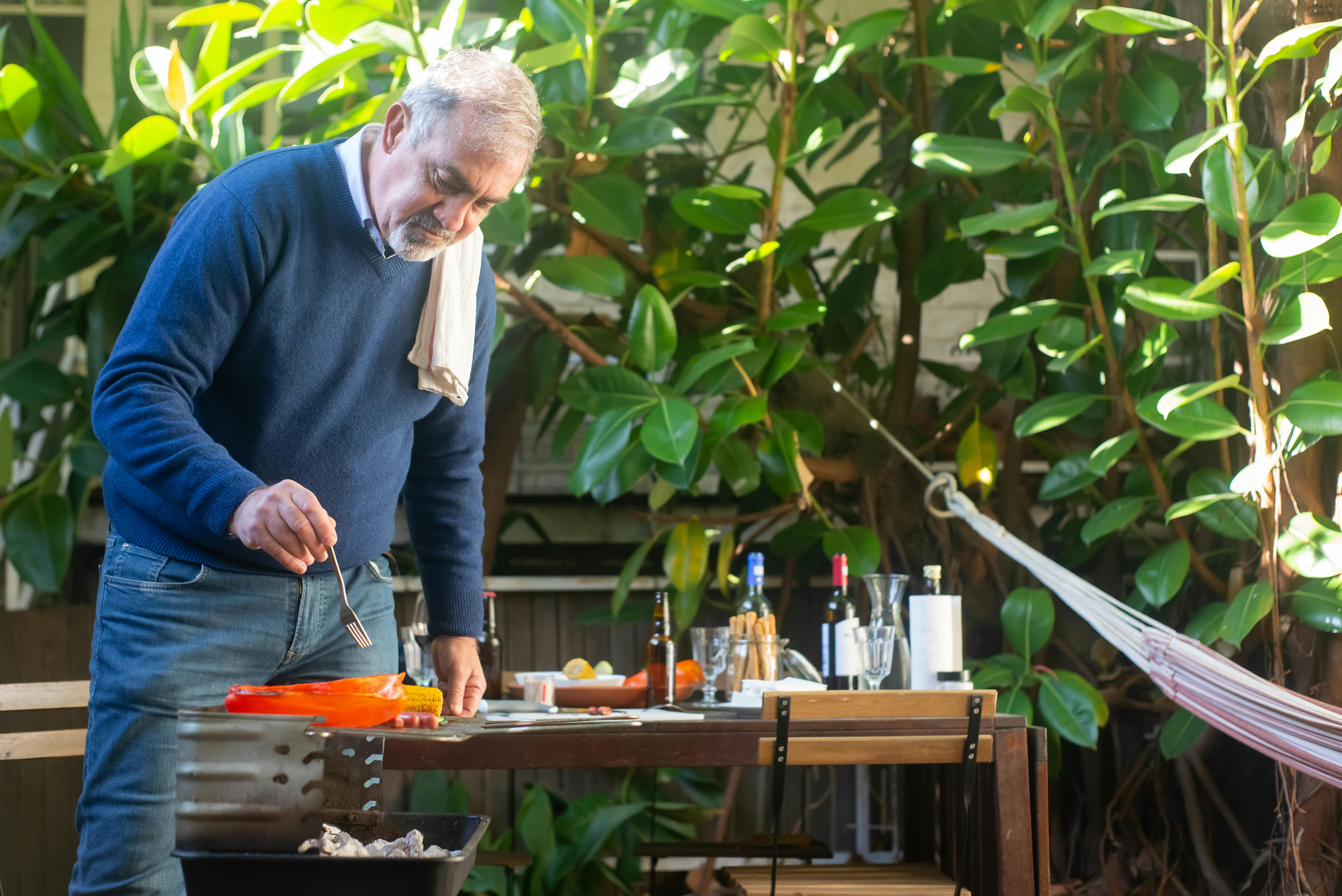 Elderly Man Grilling Barbeque · Free Stock Photo