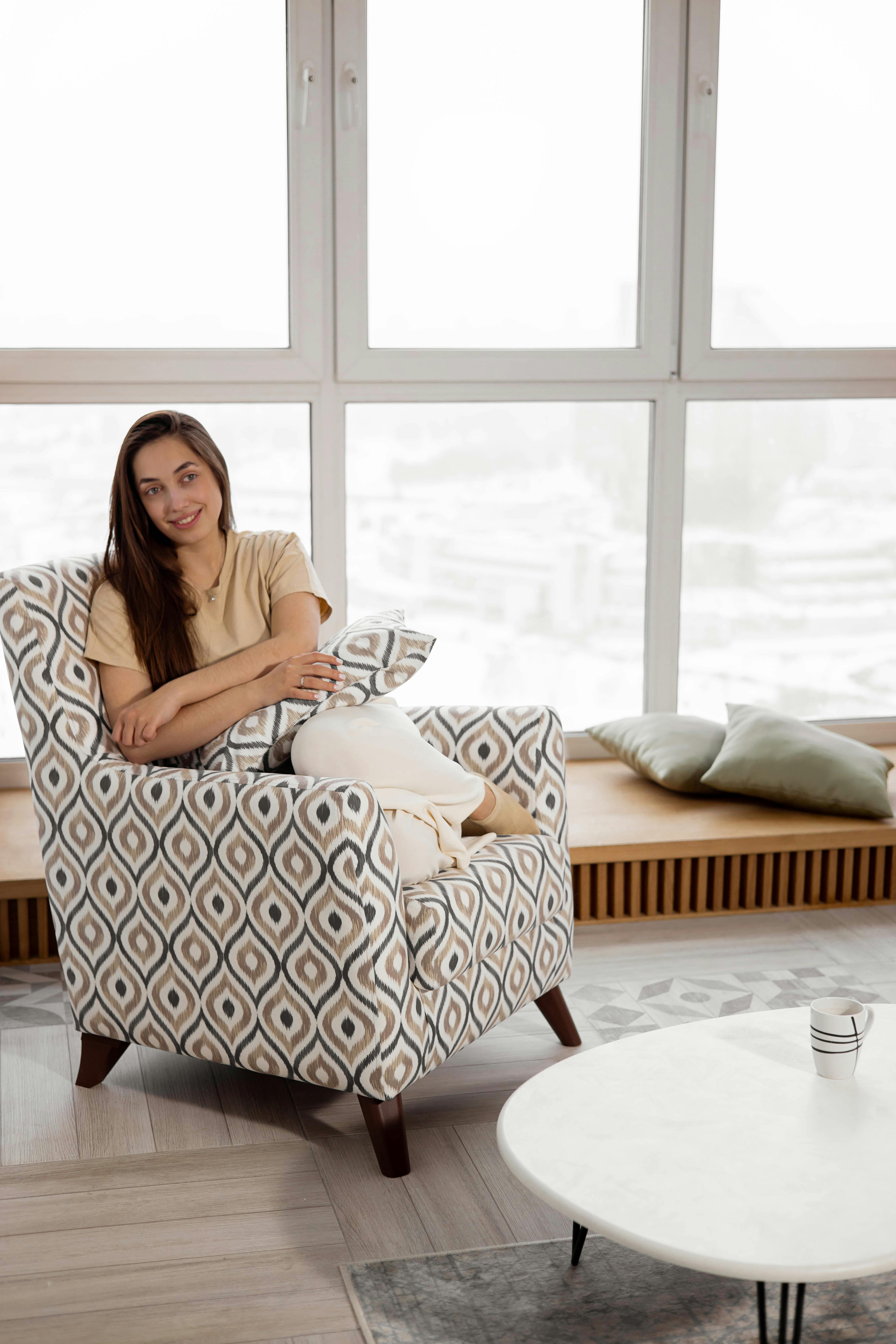 A Woman Sitting on Arm Chair · Free Stock Photo