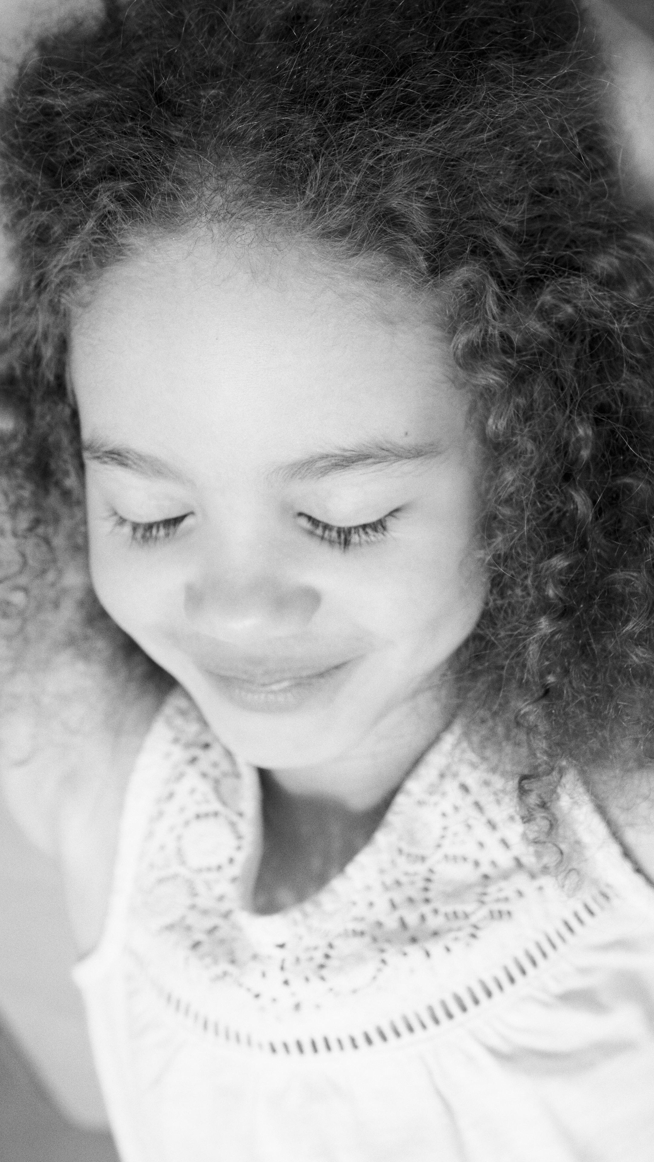 Grayscale Photo of a Child Smiling · Free Stock Photo
