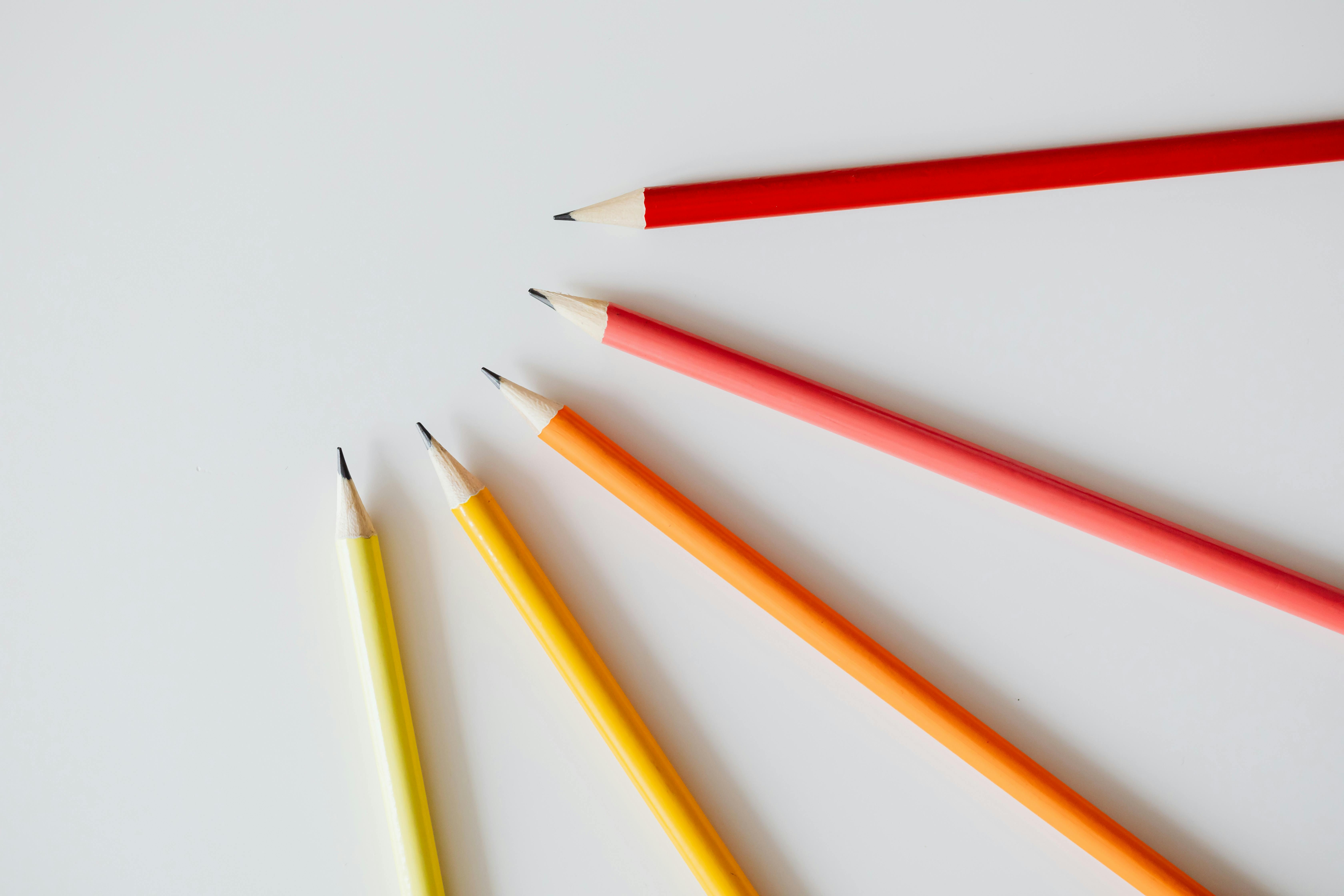 Colored Pencils with Different Colors on White Surface · Free Stock Photo