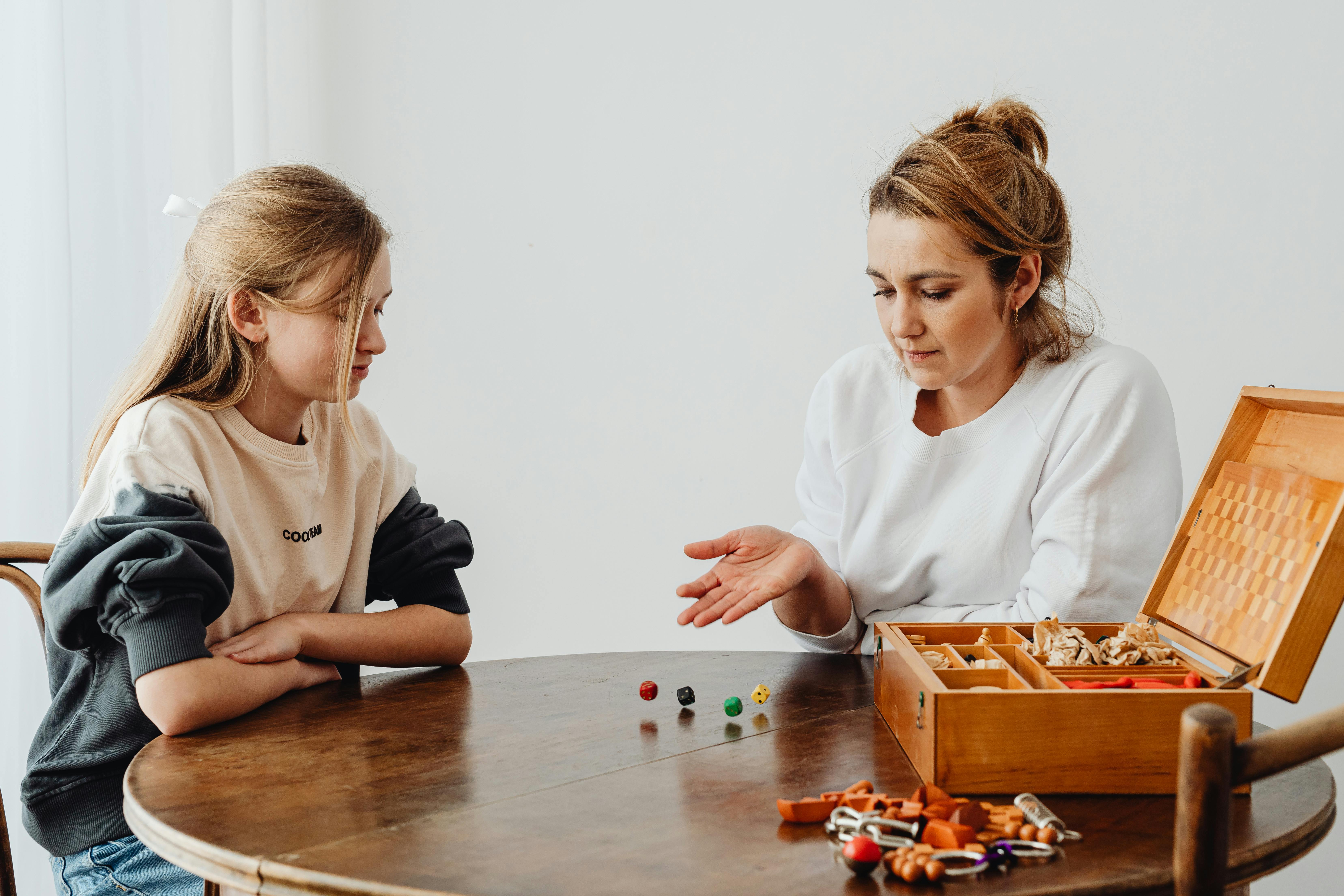 Woman in White Top Throwing Dices on the Table · Free Stock Photo