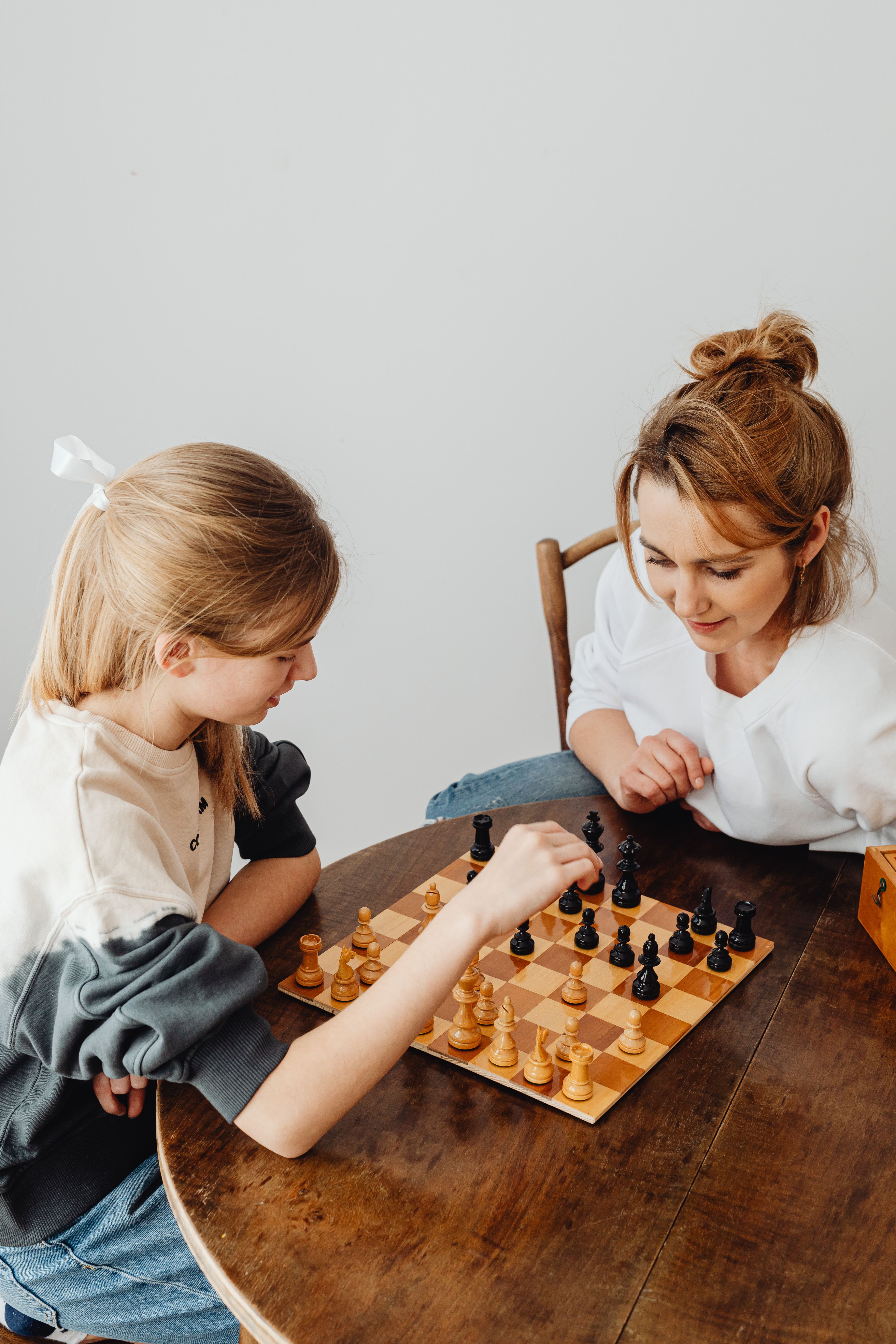 Mother and Daughter Playing Chess Together on a Wooden Table · Free ...