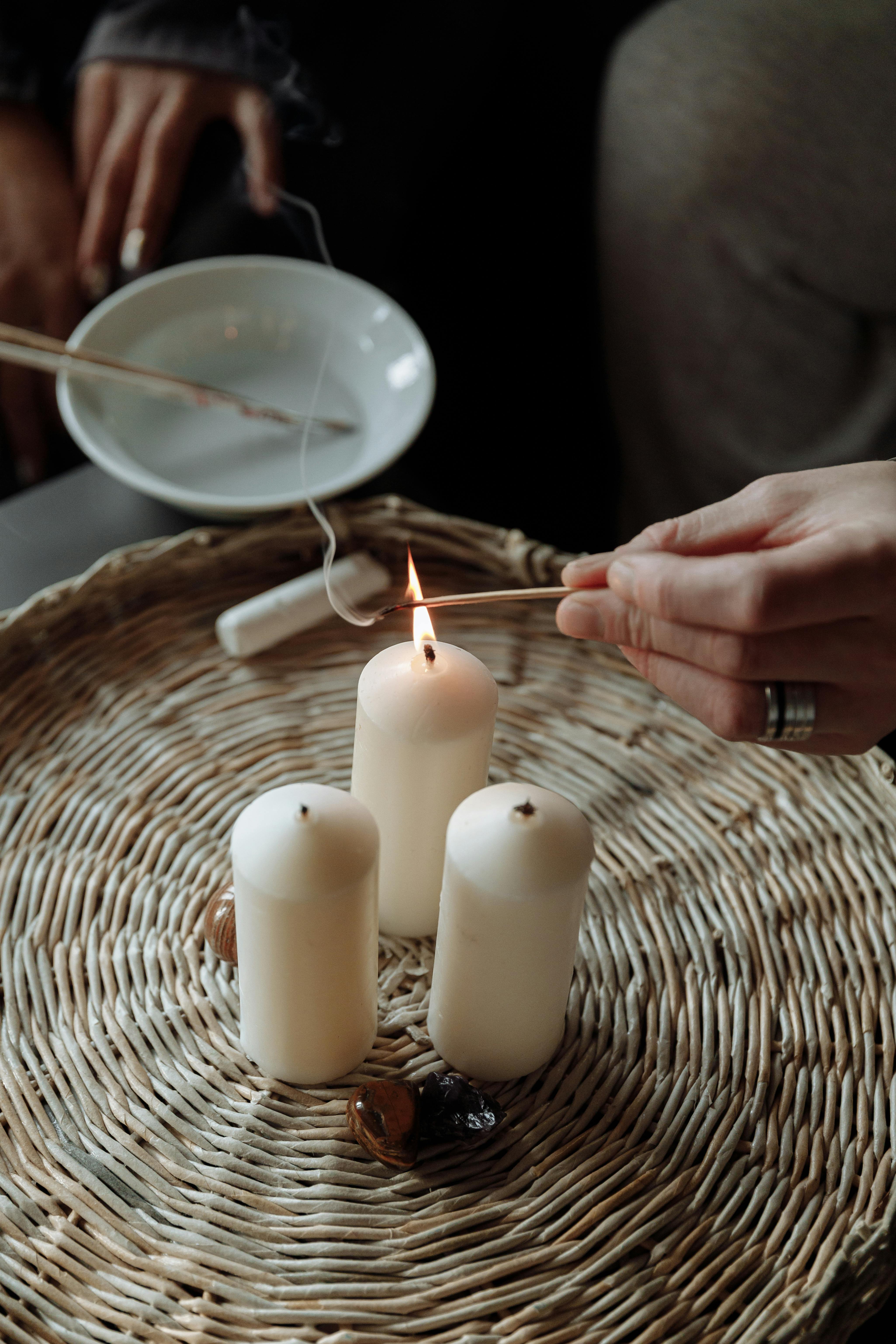A Person Lighting a Candle with a Matchstick · Free Stock Photo