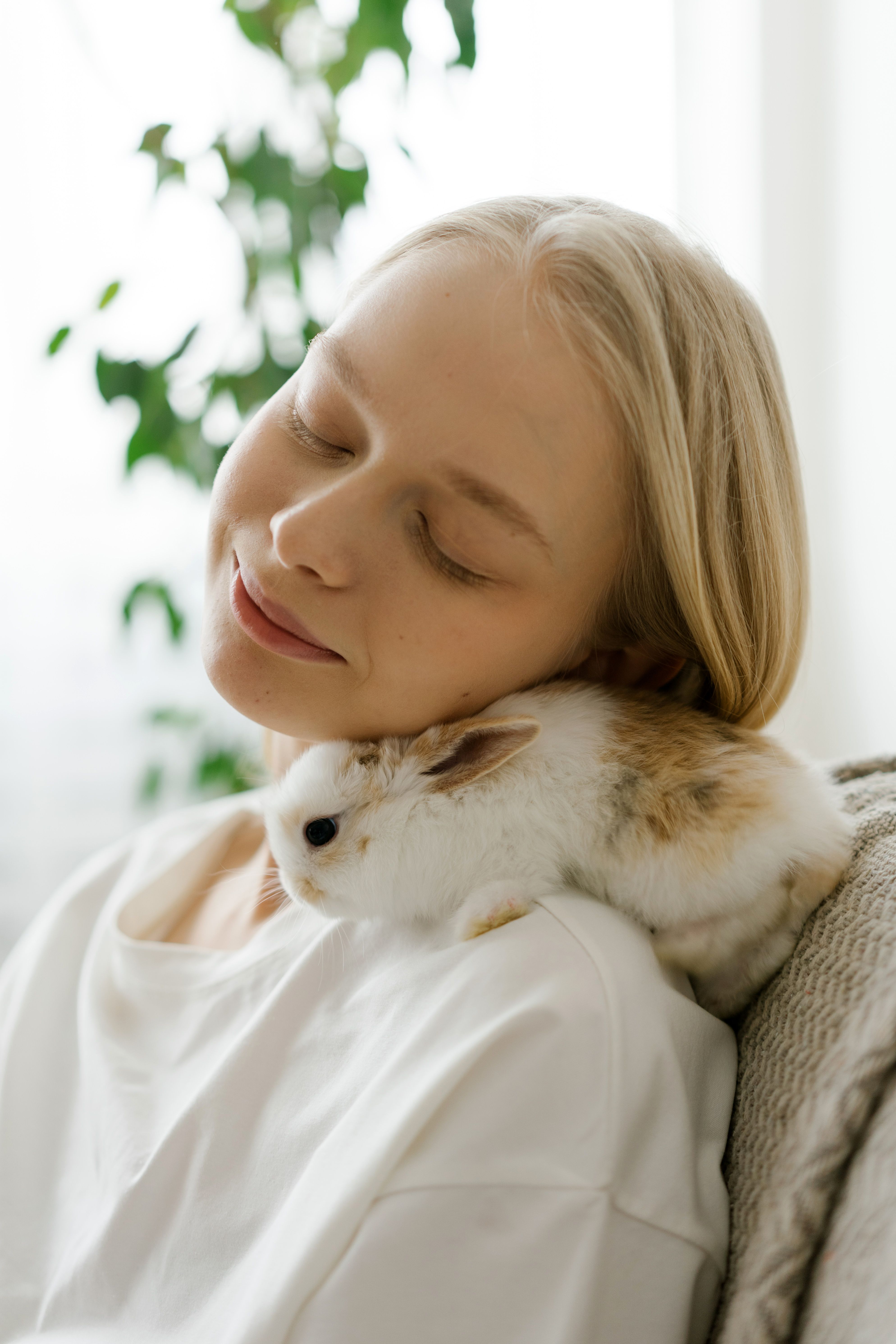 Peaceful woman cuddling with bunny · Free Stock Photo