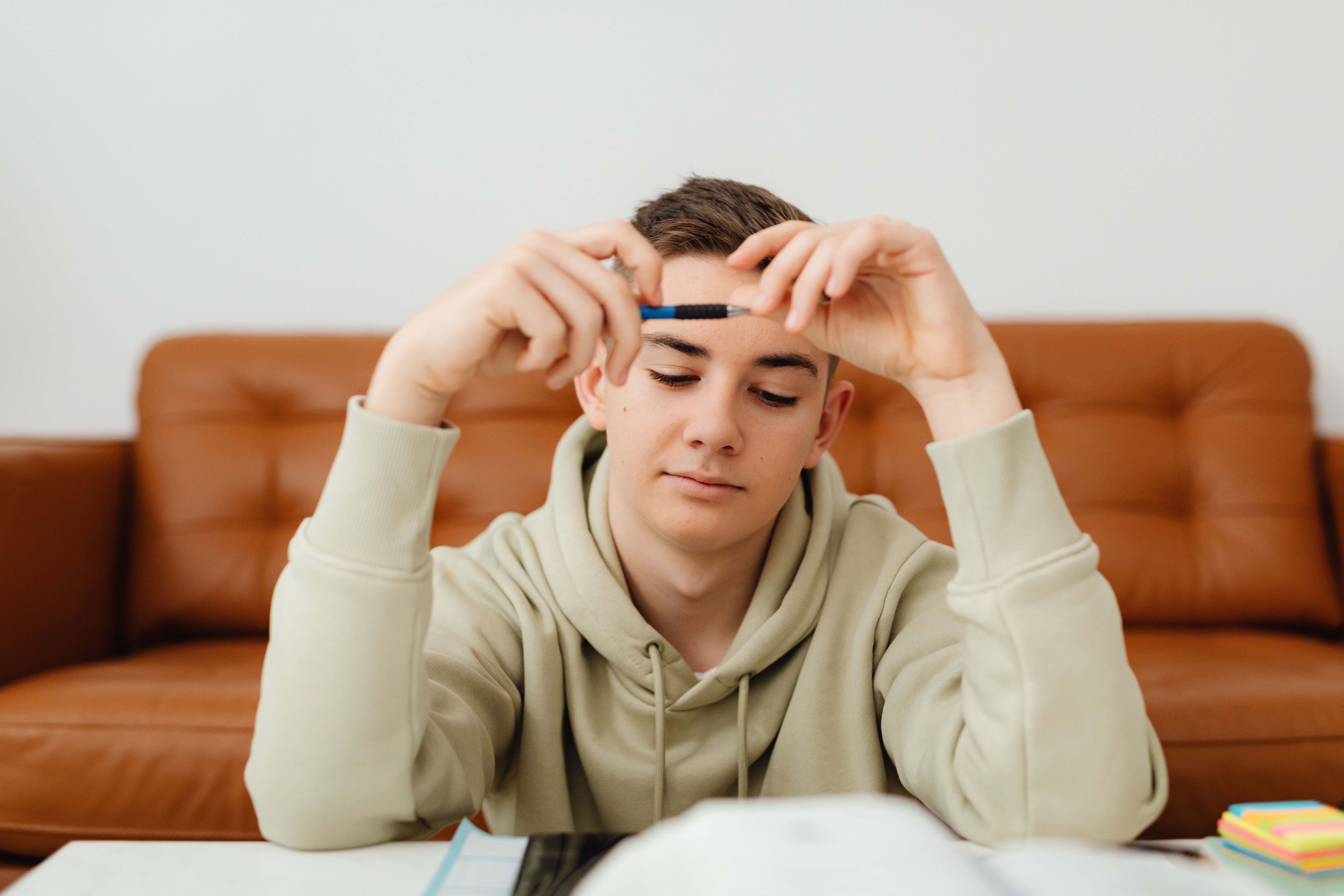 Close-Up Shot of a Boy Holding a Pen · Free Stock Photo