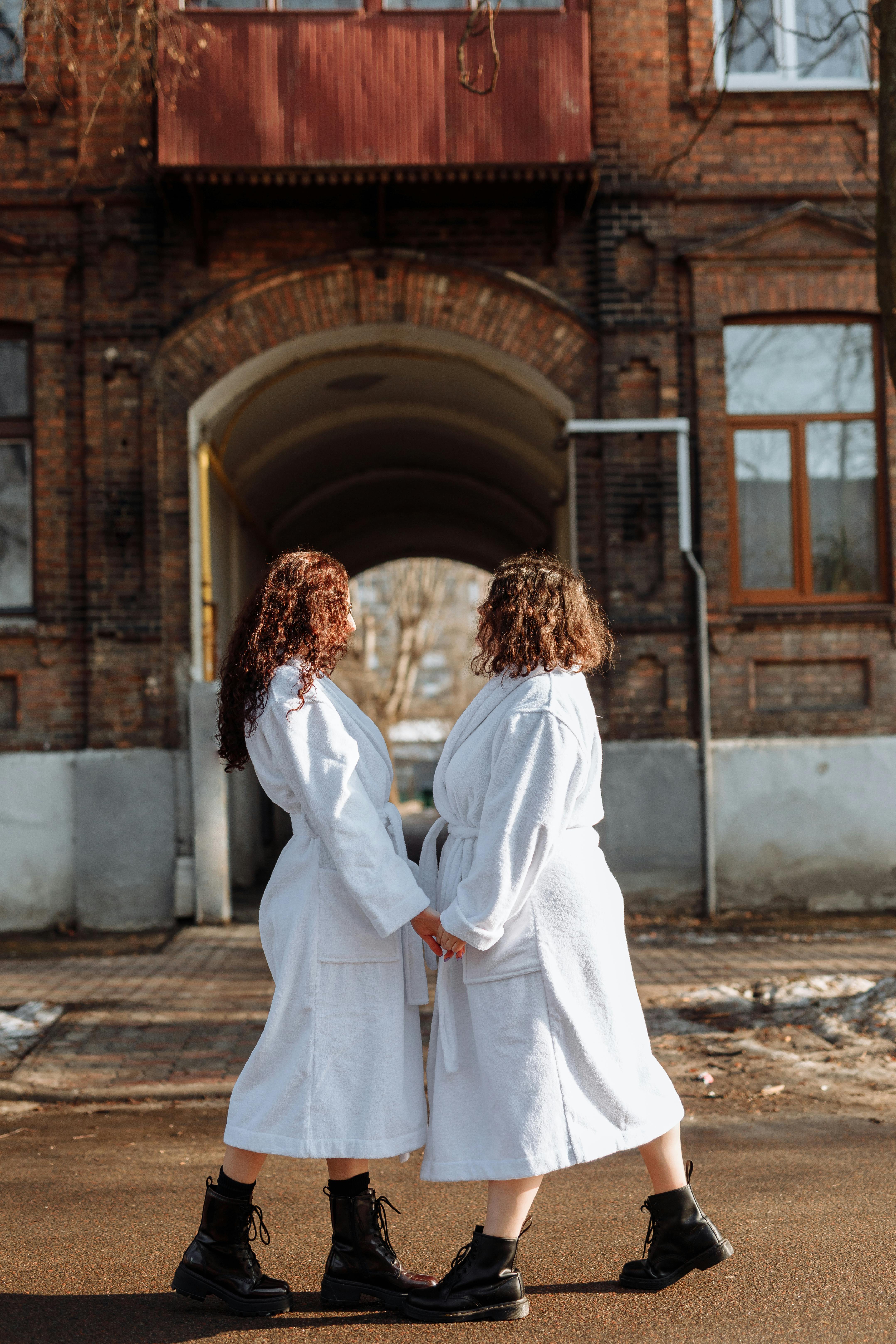 Women in White Robe Walking on Street · Free Stock Photo